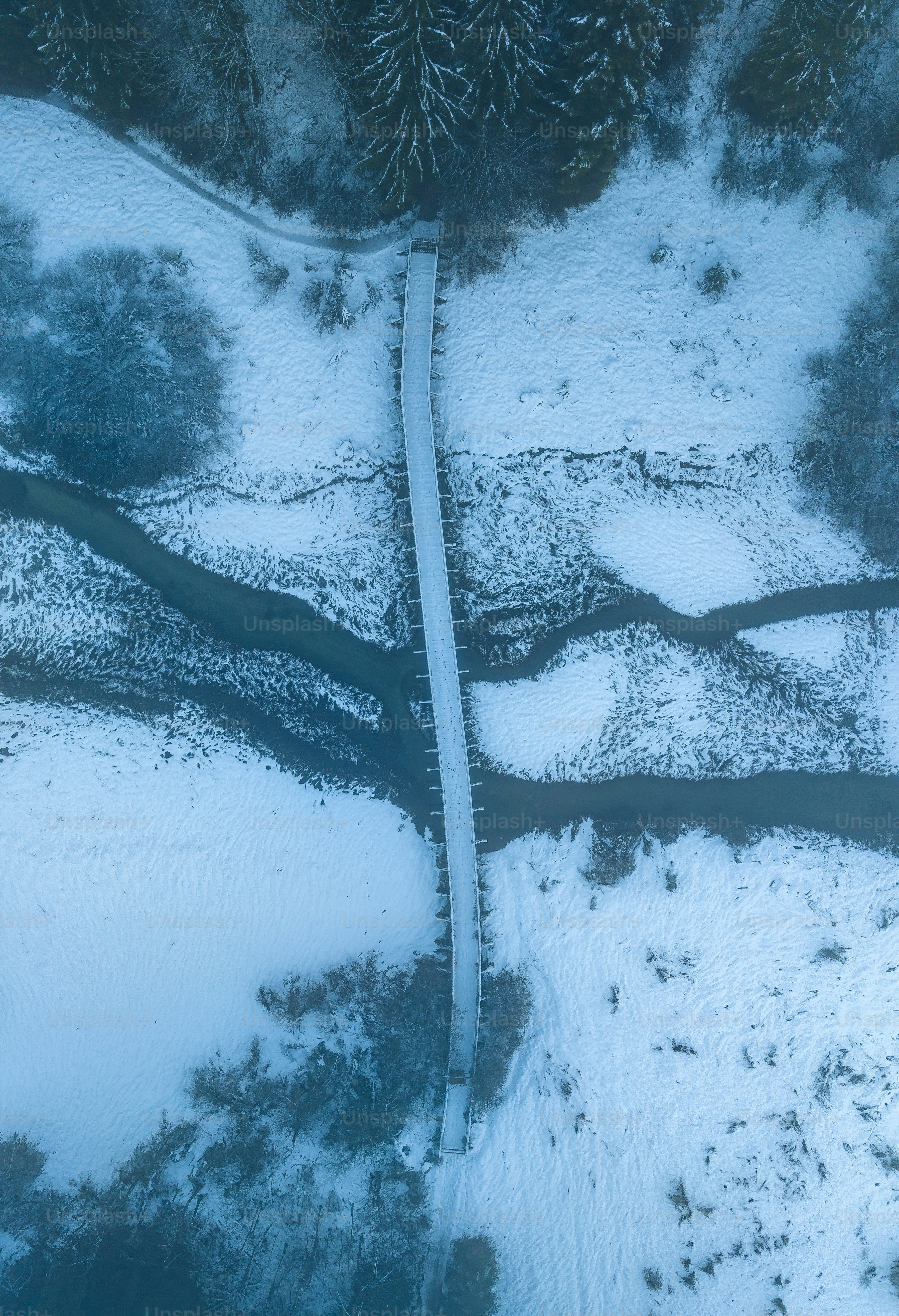 An aerial view of a road in the snow photo – Blue snow Image on Unsplash