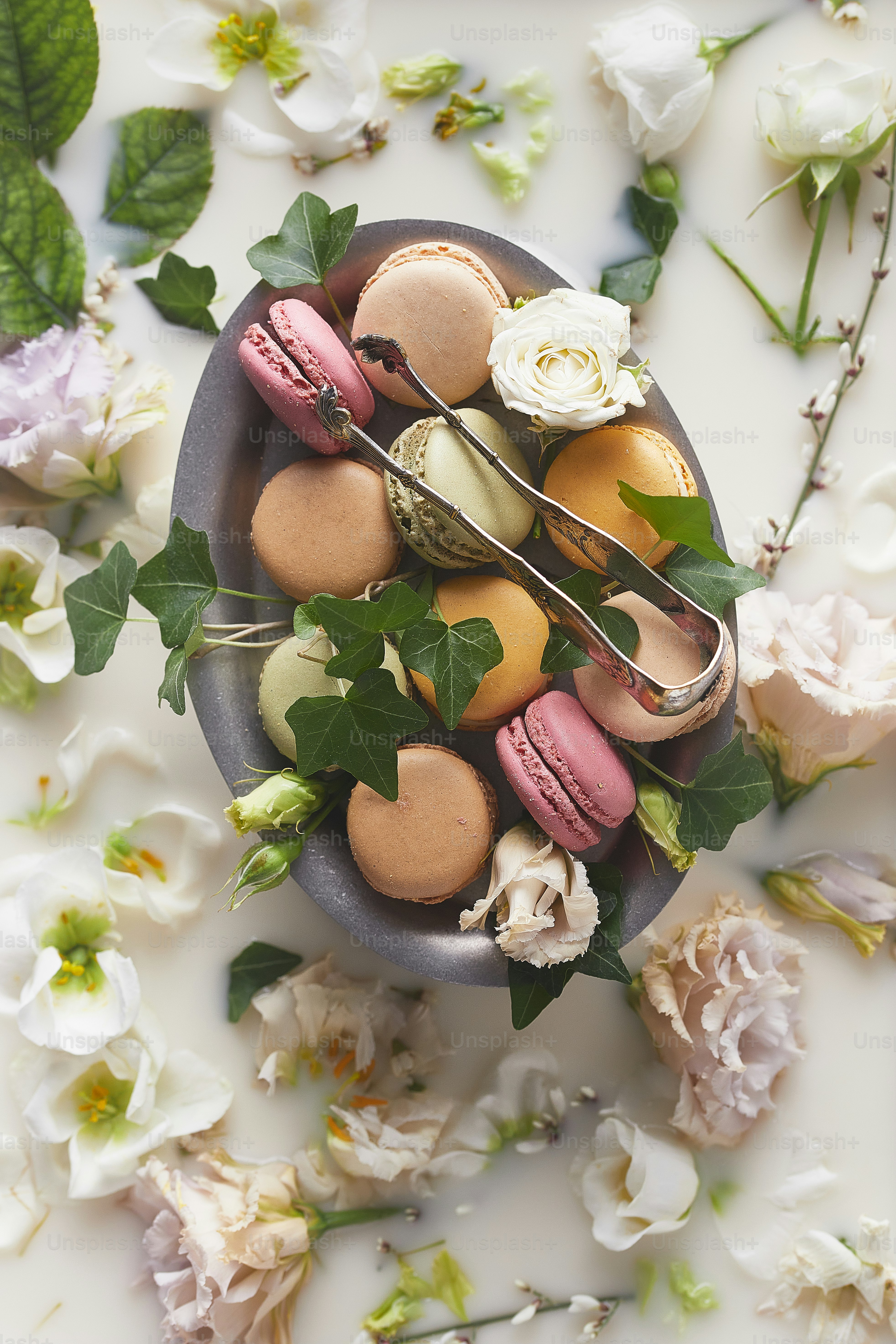 A bowl of macaroons and flowers on a table photo – Wedding details ...