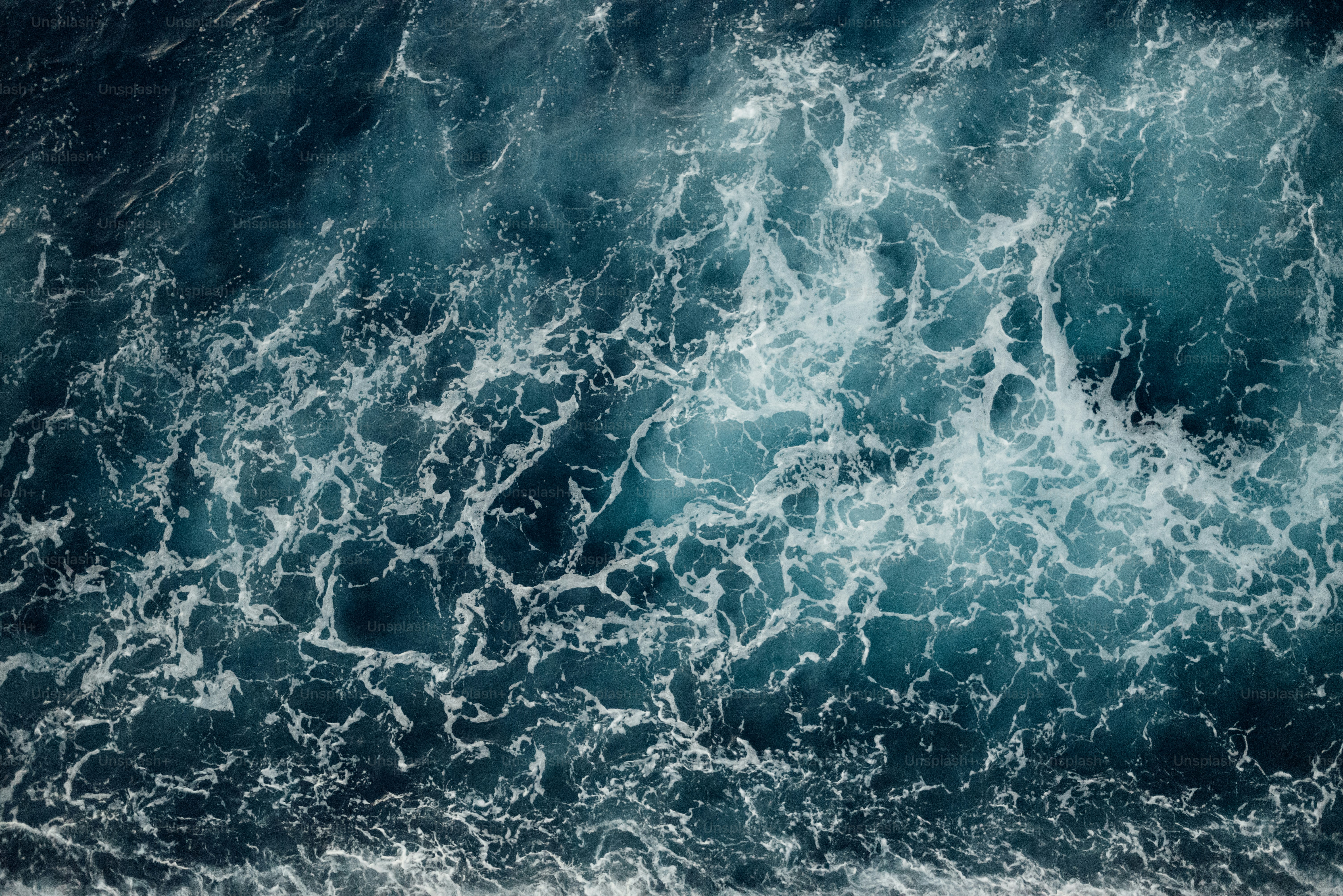 A large body of water covered in waves photo – Texture Image on Unsplash