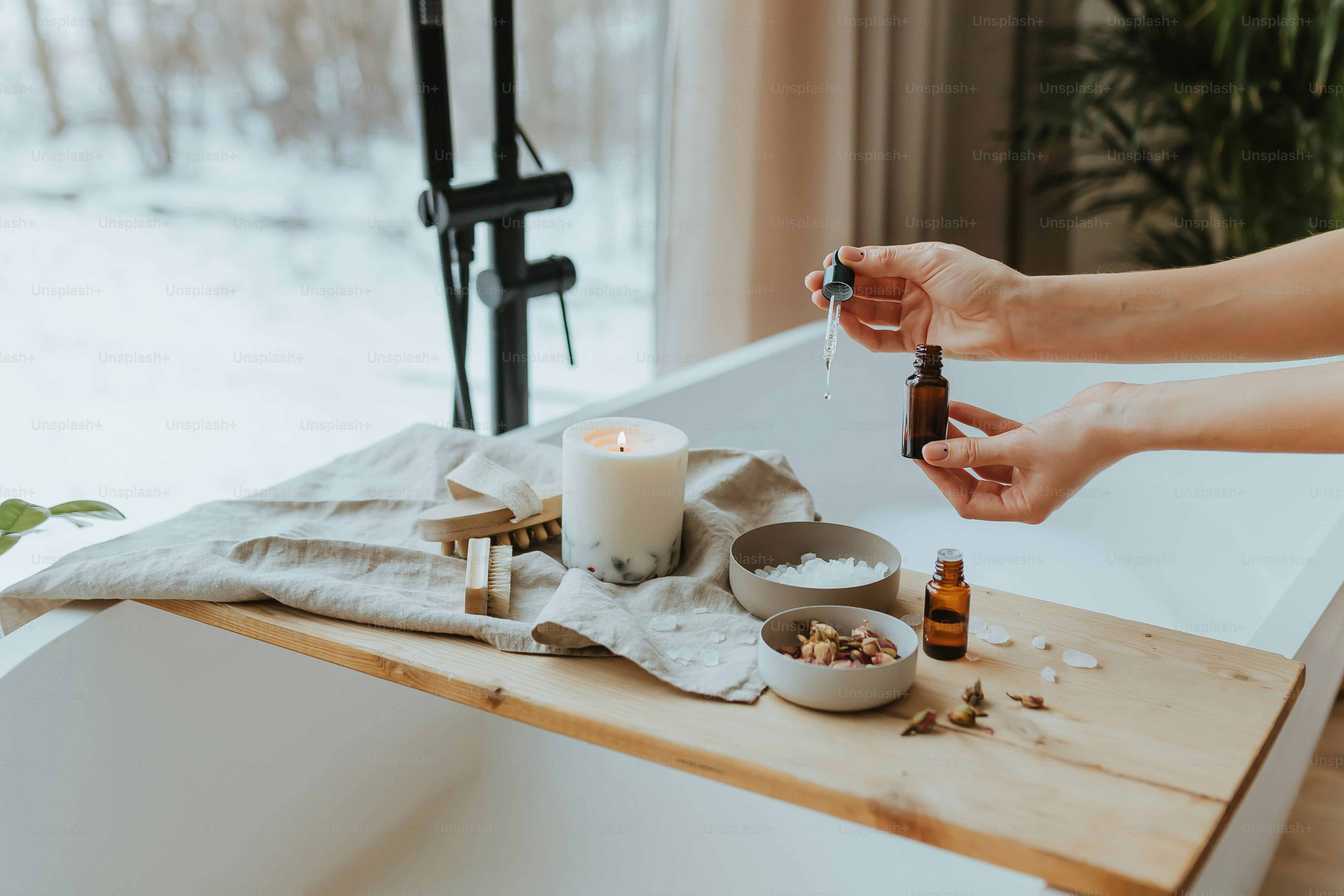 A woman is holding a bottle of essential oils photo – Essential oils ...