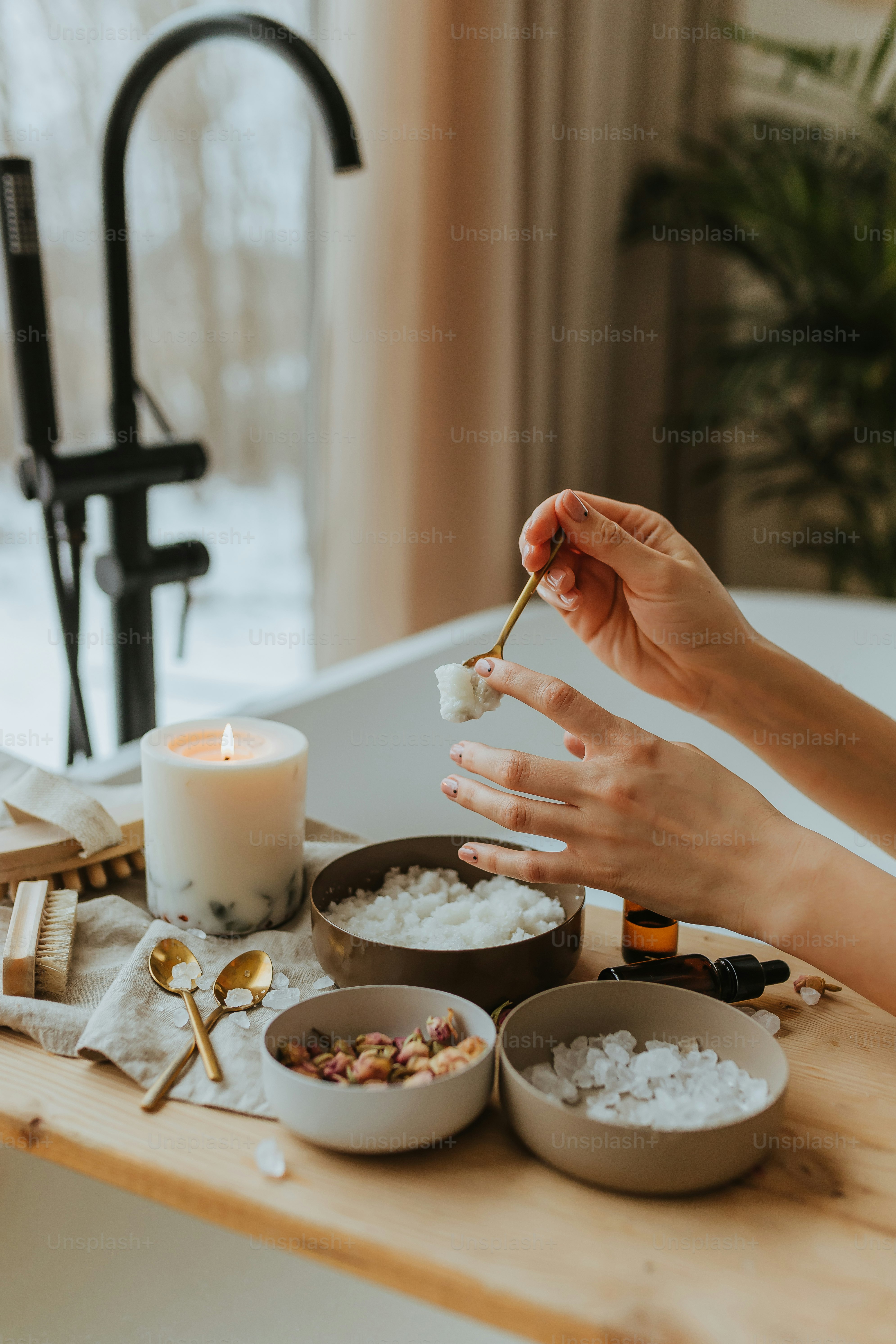 A woman eating rice with a candle in the background photo – Essential ...