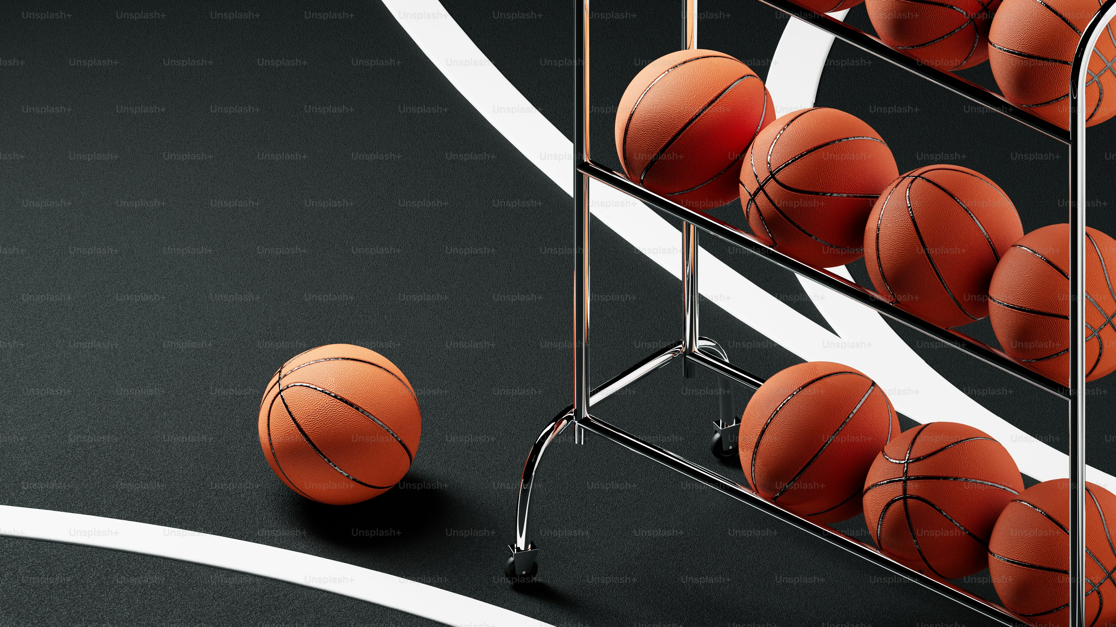 A rack with basketballs sitting on top of a basketball court photo ...