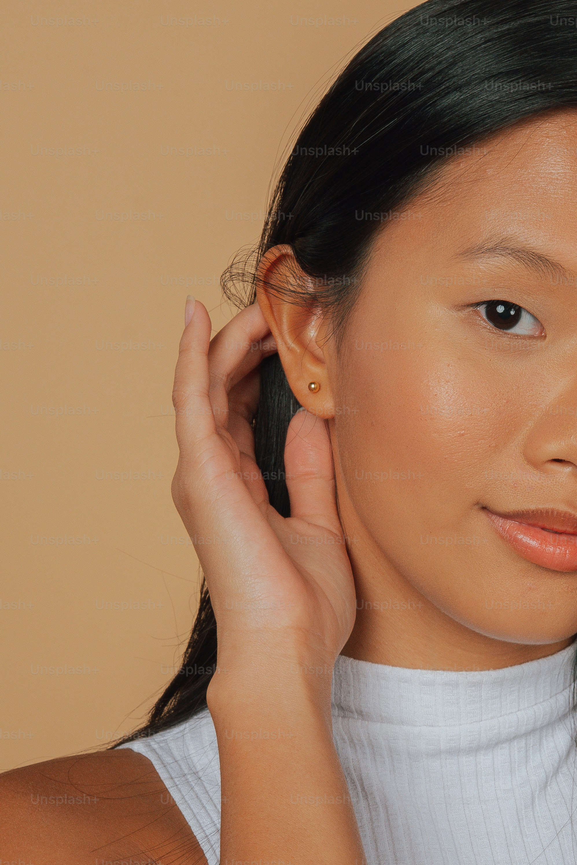A woman wearing a pair of ear piercings photo – International womens ...