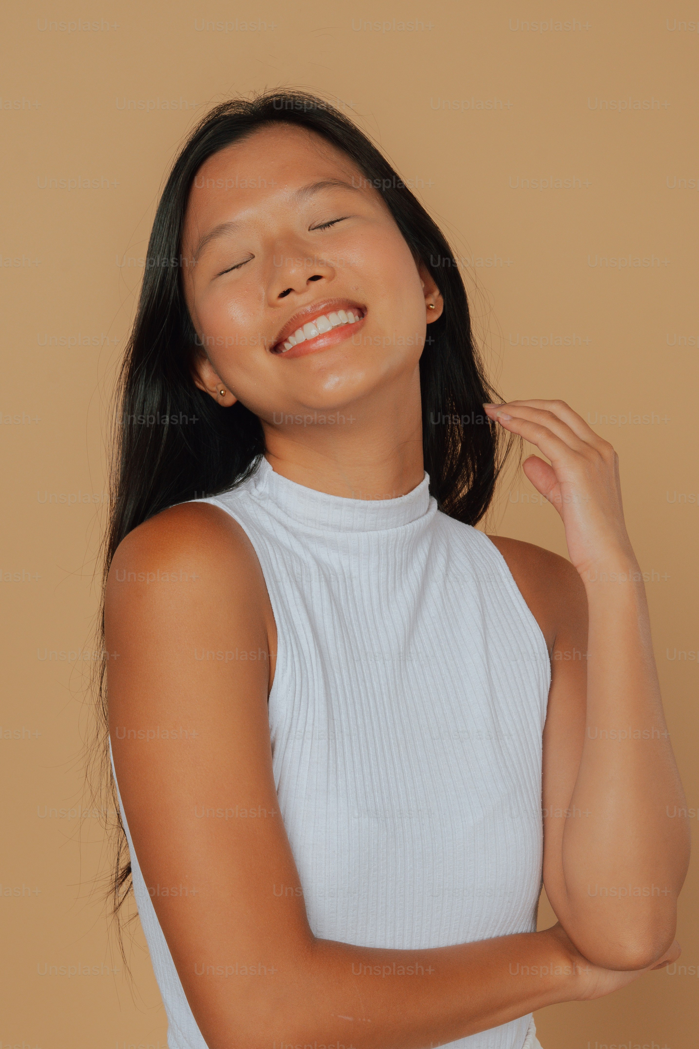 A woman with her eyes closed smiling photo – Laughing Image on Unsplash