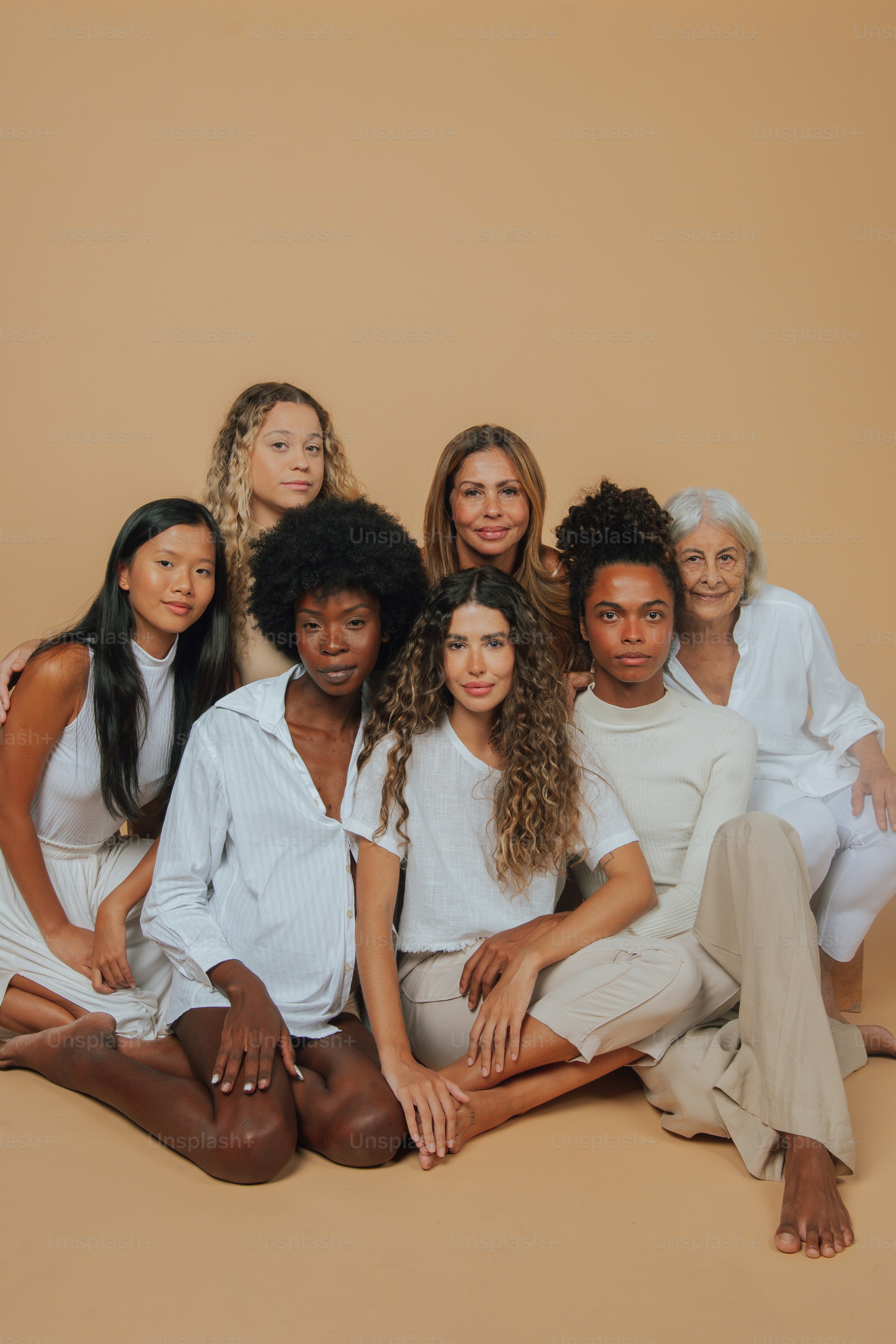 A group of people sitting next to each other photo – Accepting body ...