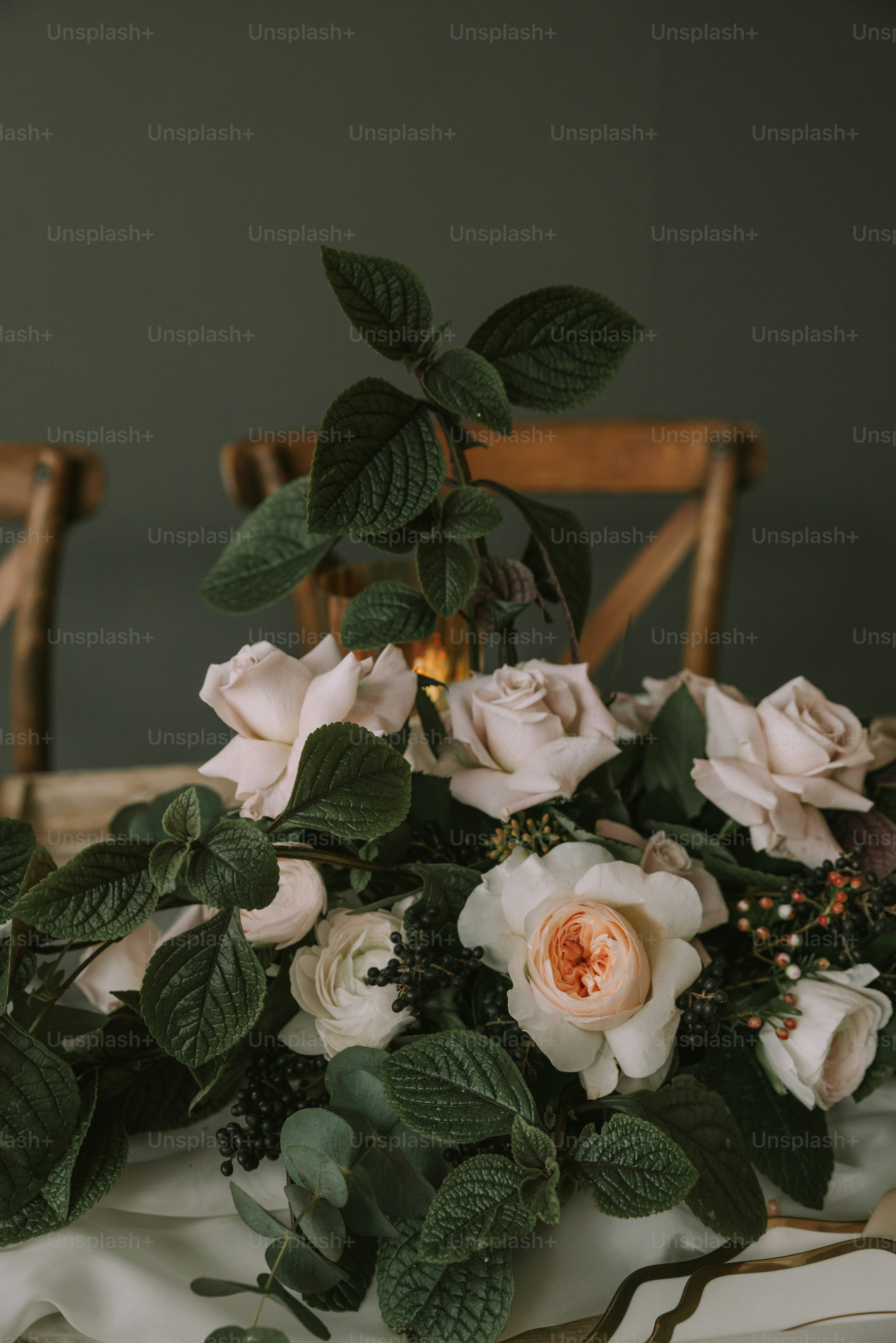 A bouquet of flowers sitting on top of a table photo – Pink roses Image ...
