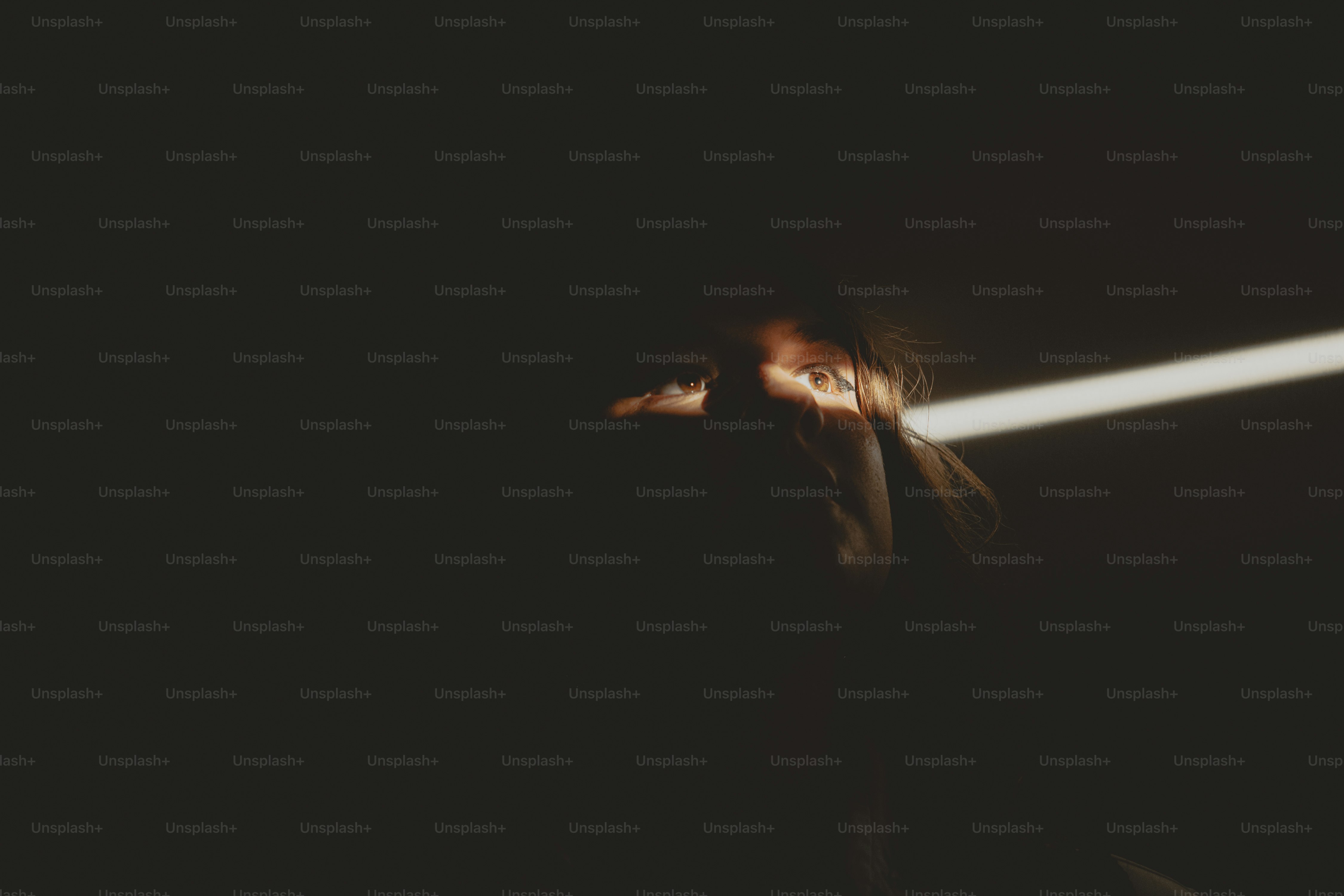 A woman holding a flashlight in the dark photo – Shadow woman Image on ...