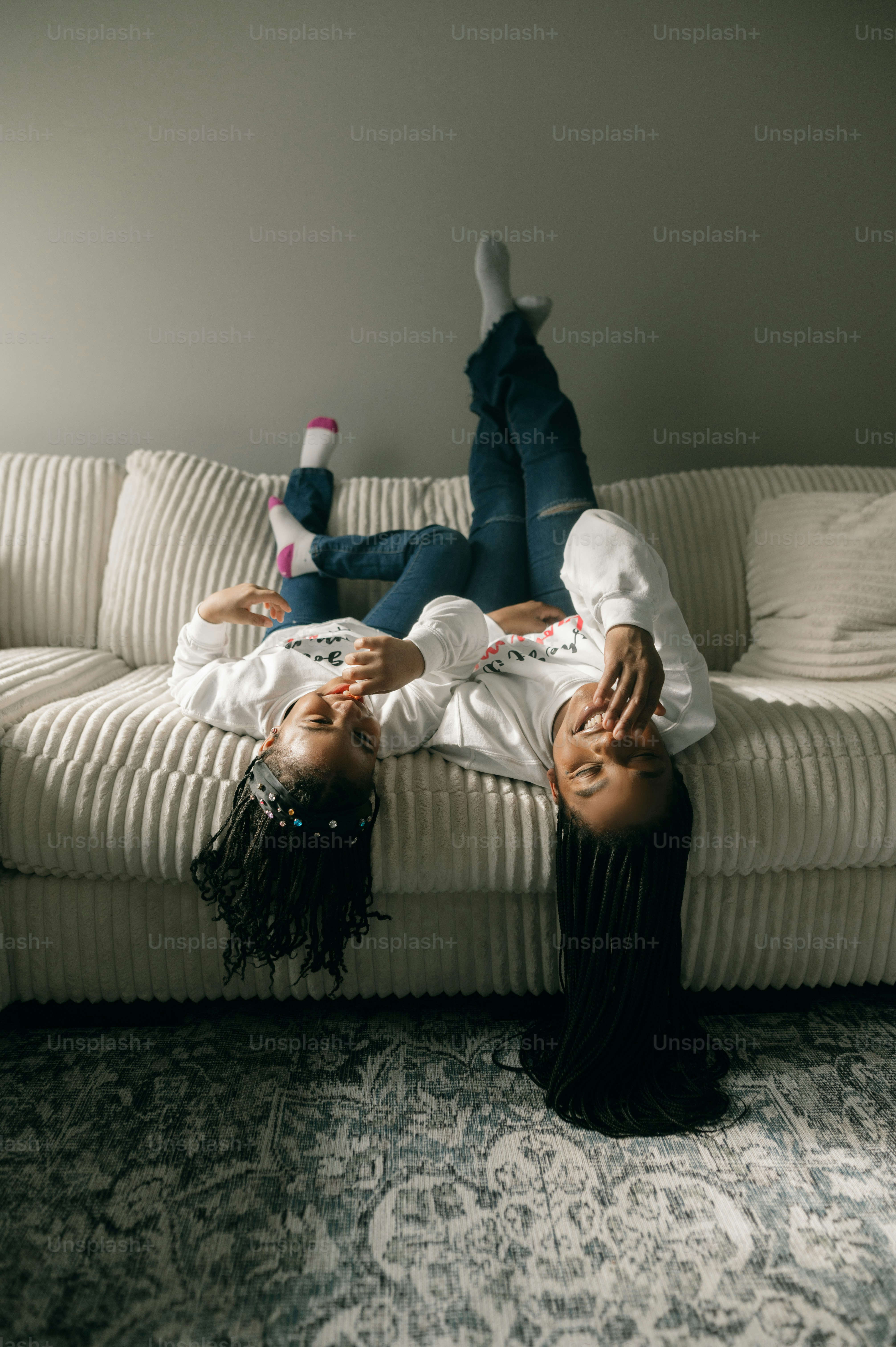 Two people laying on a couch in a room photo – Smile Image on Unsplash