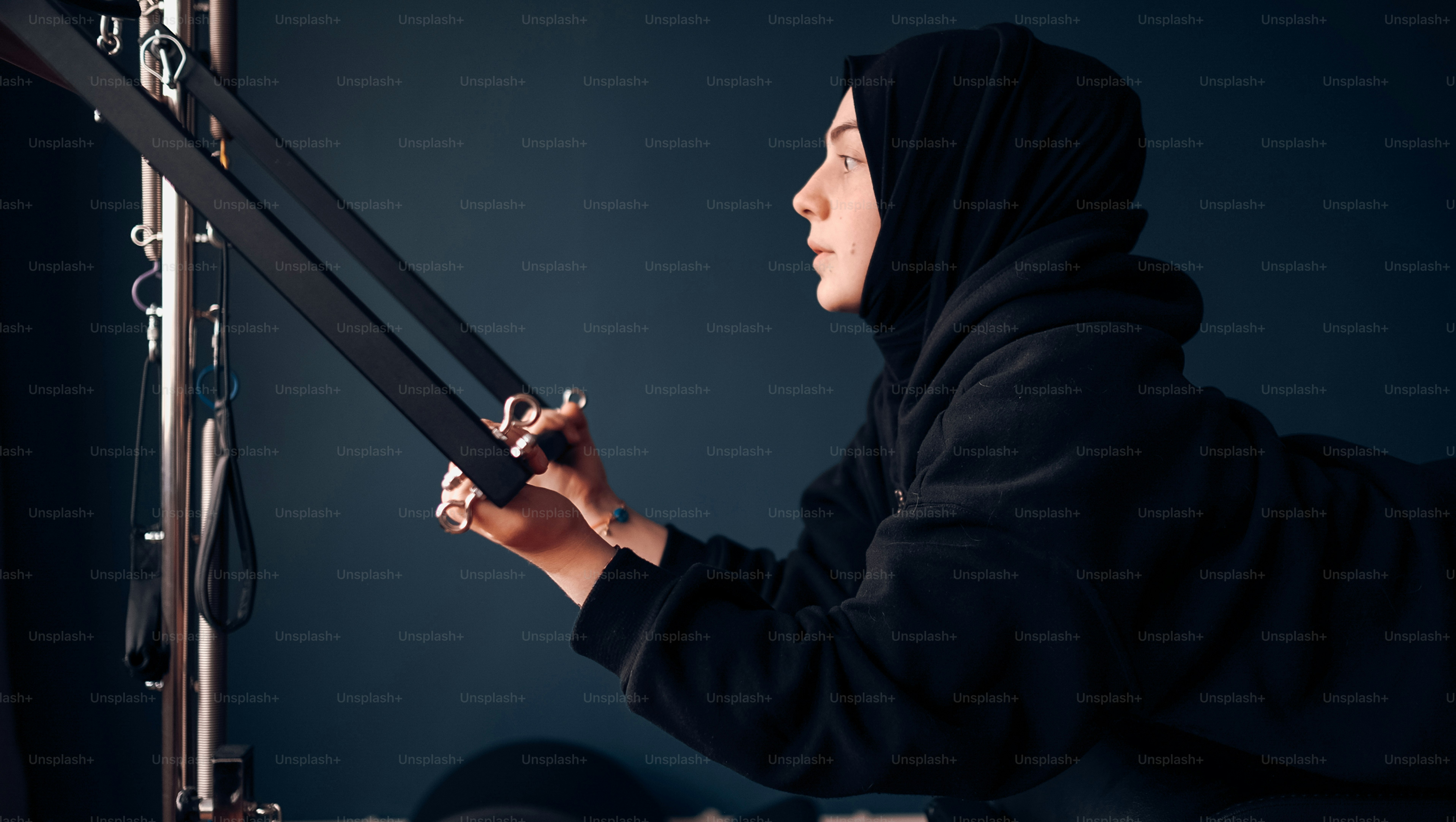 A woman in a hijab is working on a machine photo – Woman Image on Unsplash