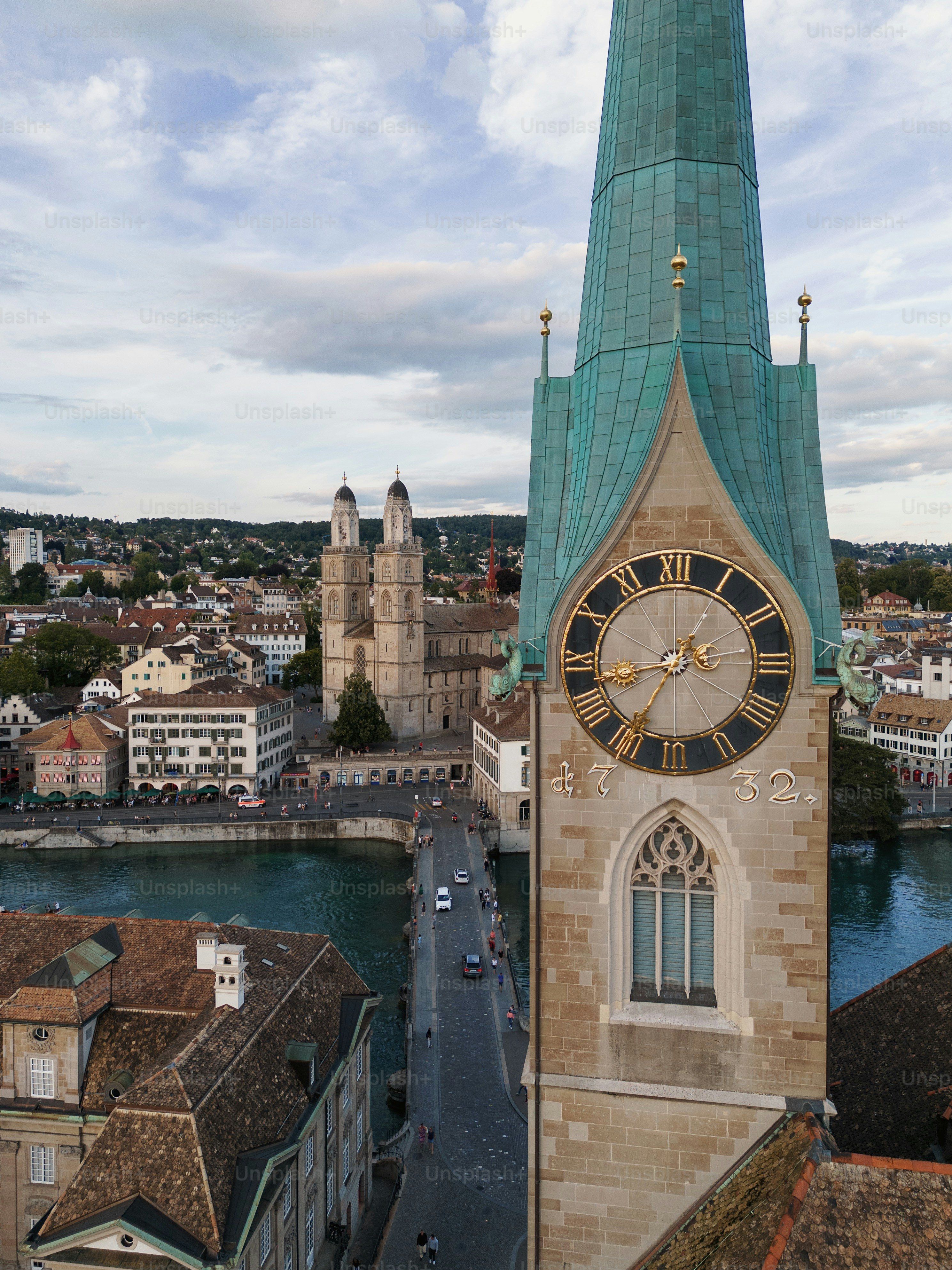 A large clock tower towering over a city photo – Switzerland Image on ...