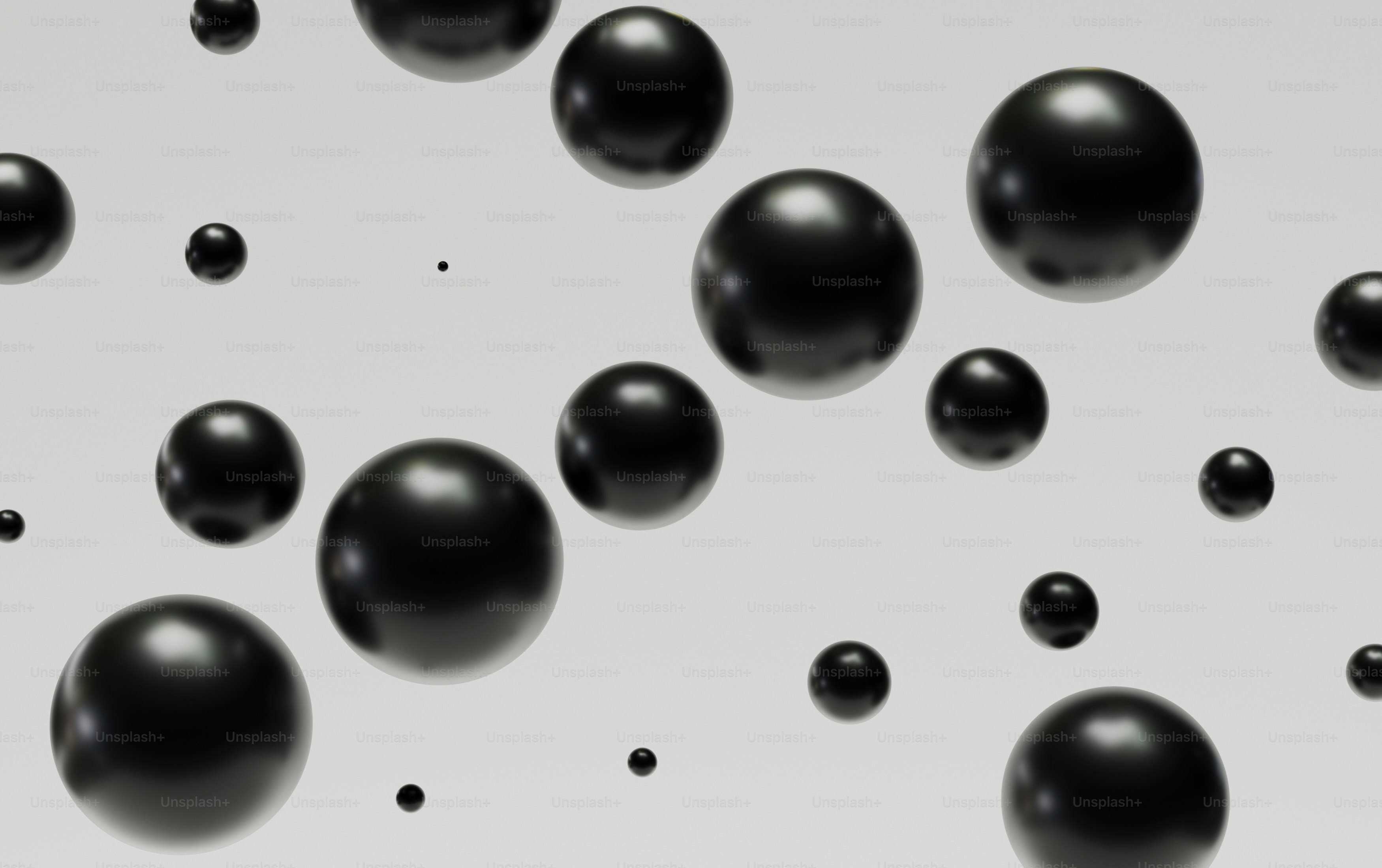 A group of black balls floating on top of a white surface photo – 3d ...