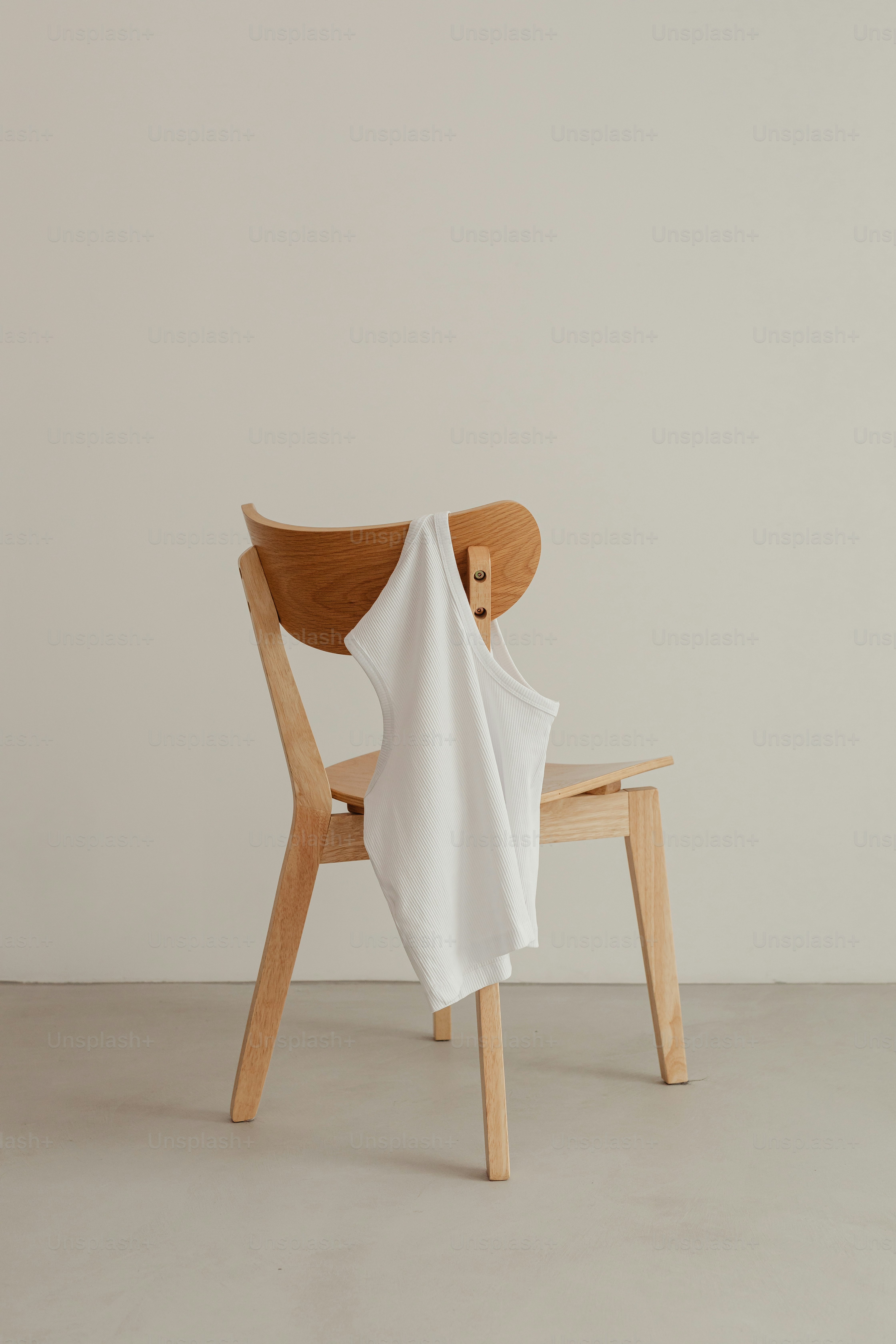 A wooden chair with a white cloth draped over it photo – Fashion Image ...