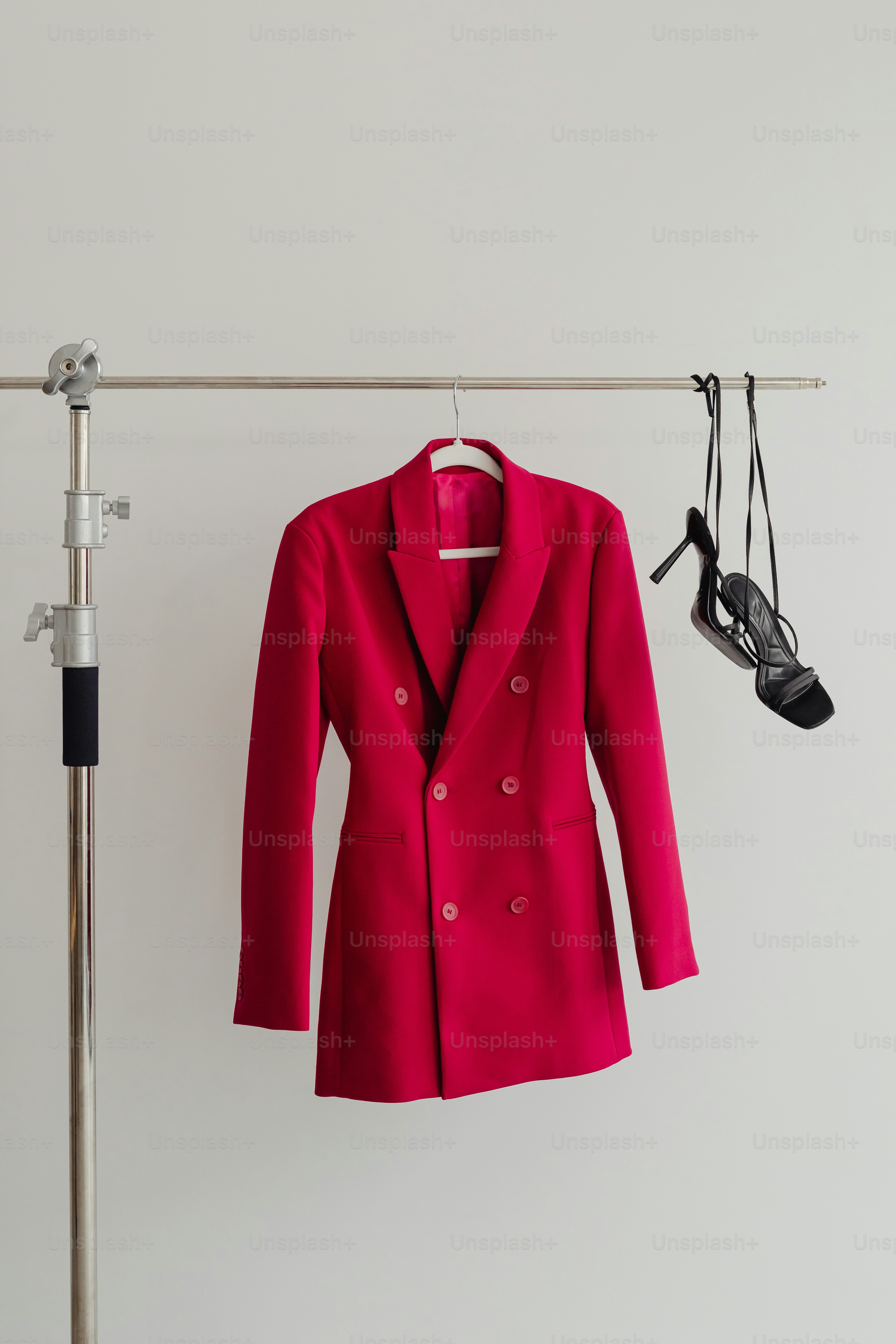 A red jacket hanging on a clothes rack photo – Fashion Image on Unsplash