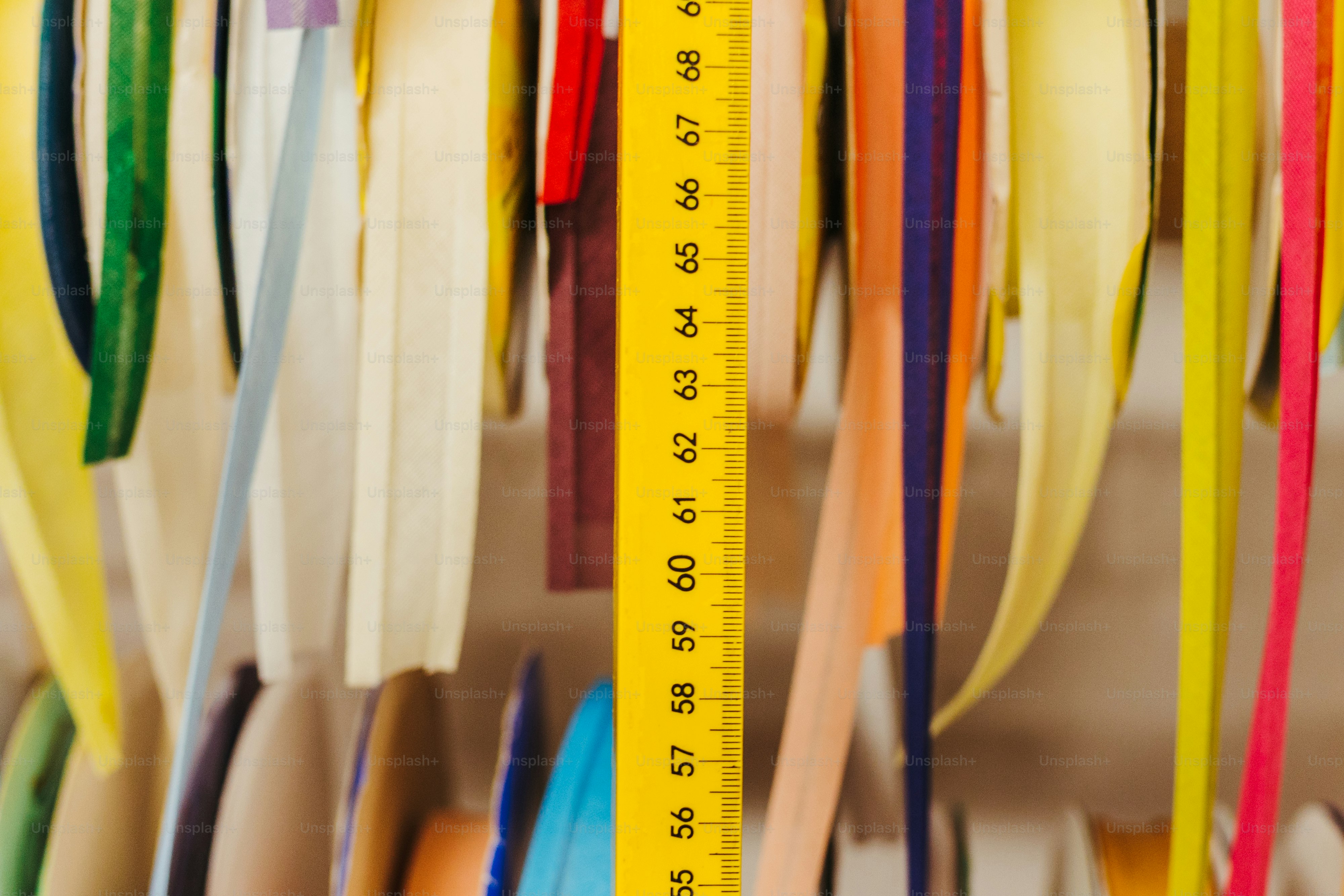 A measuring tape is hanging on a wall photo – Clothing Image on Unsplash