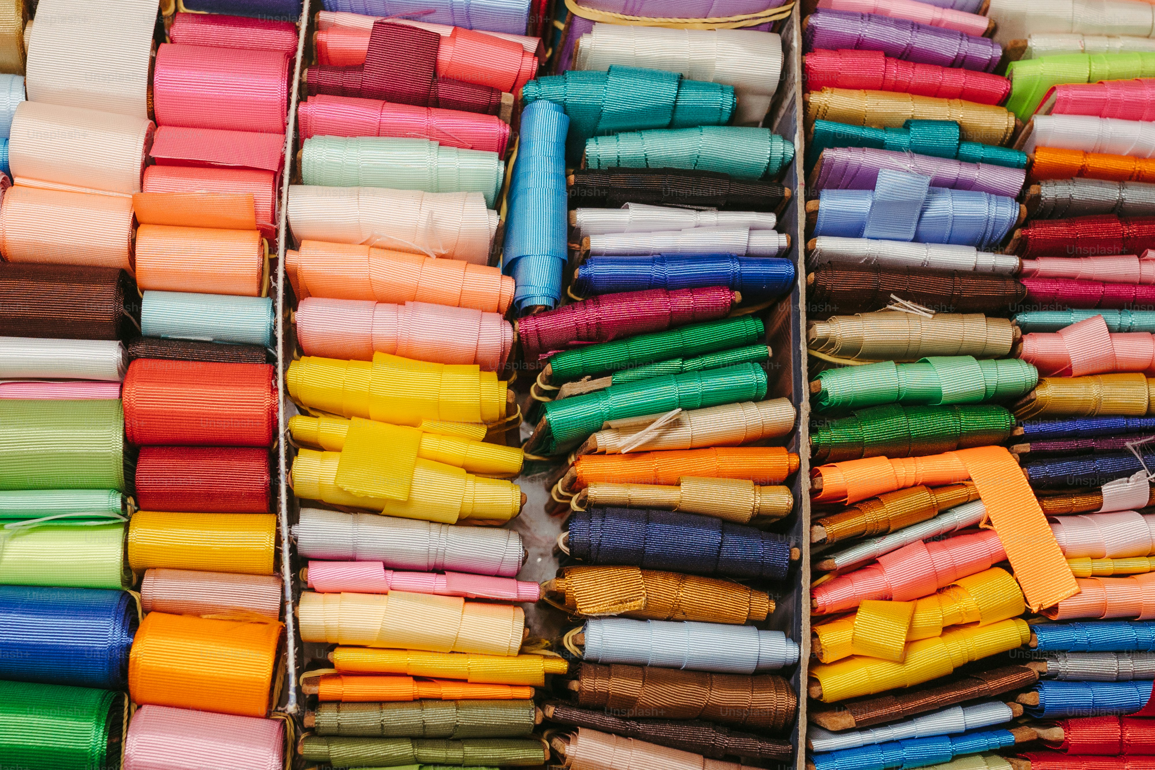 A bunch of different colors of fabric on display photo – Haberdashery ...