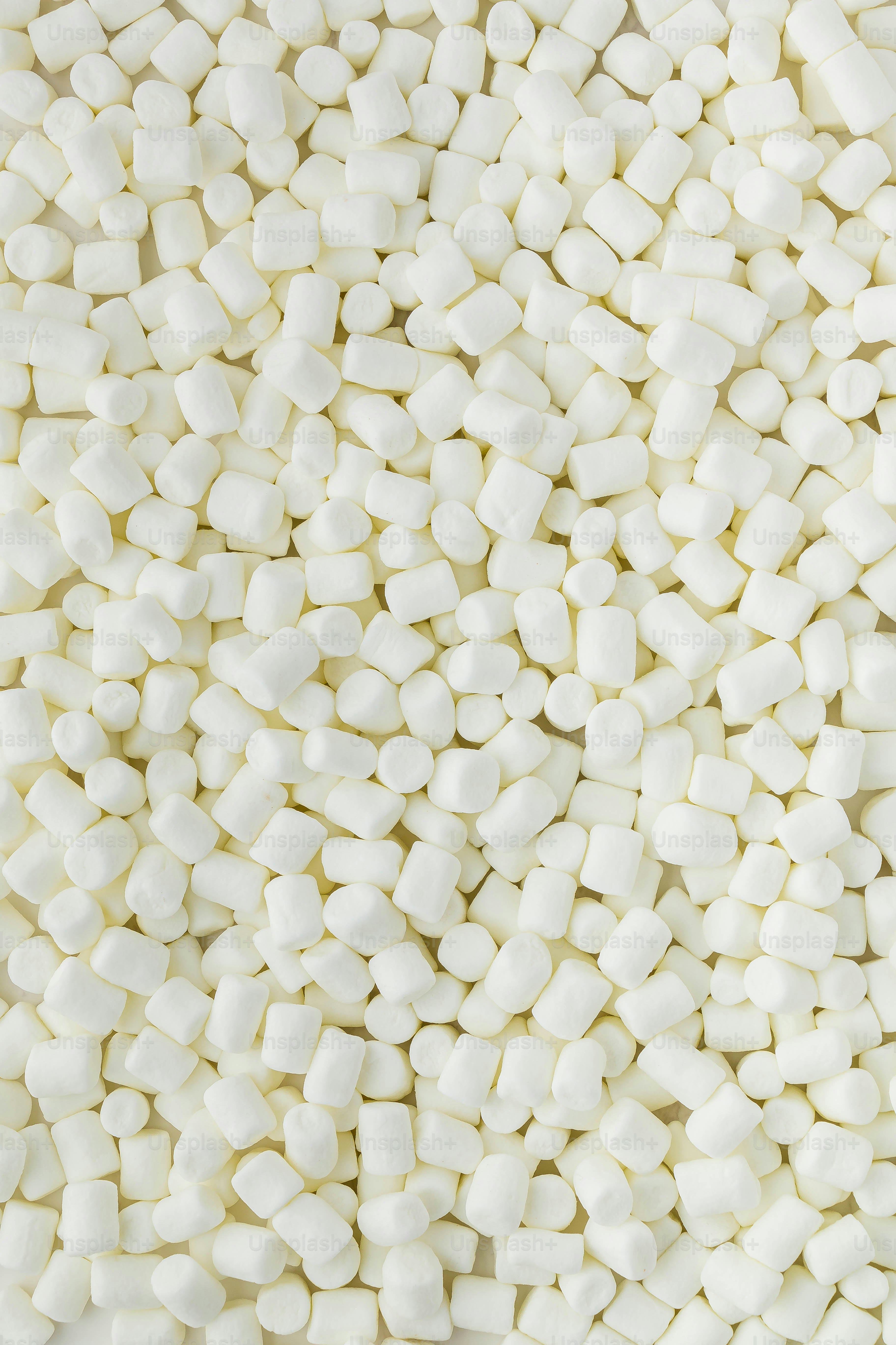 A pile of white marshmallows sitting next to each other photo ...
