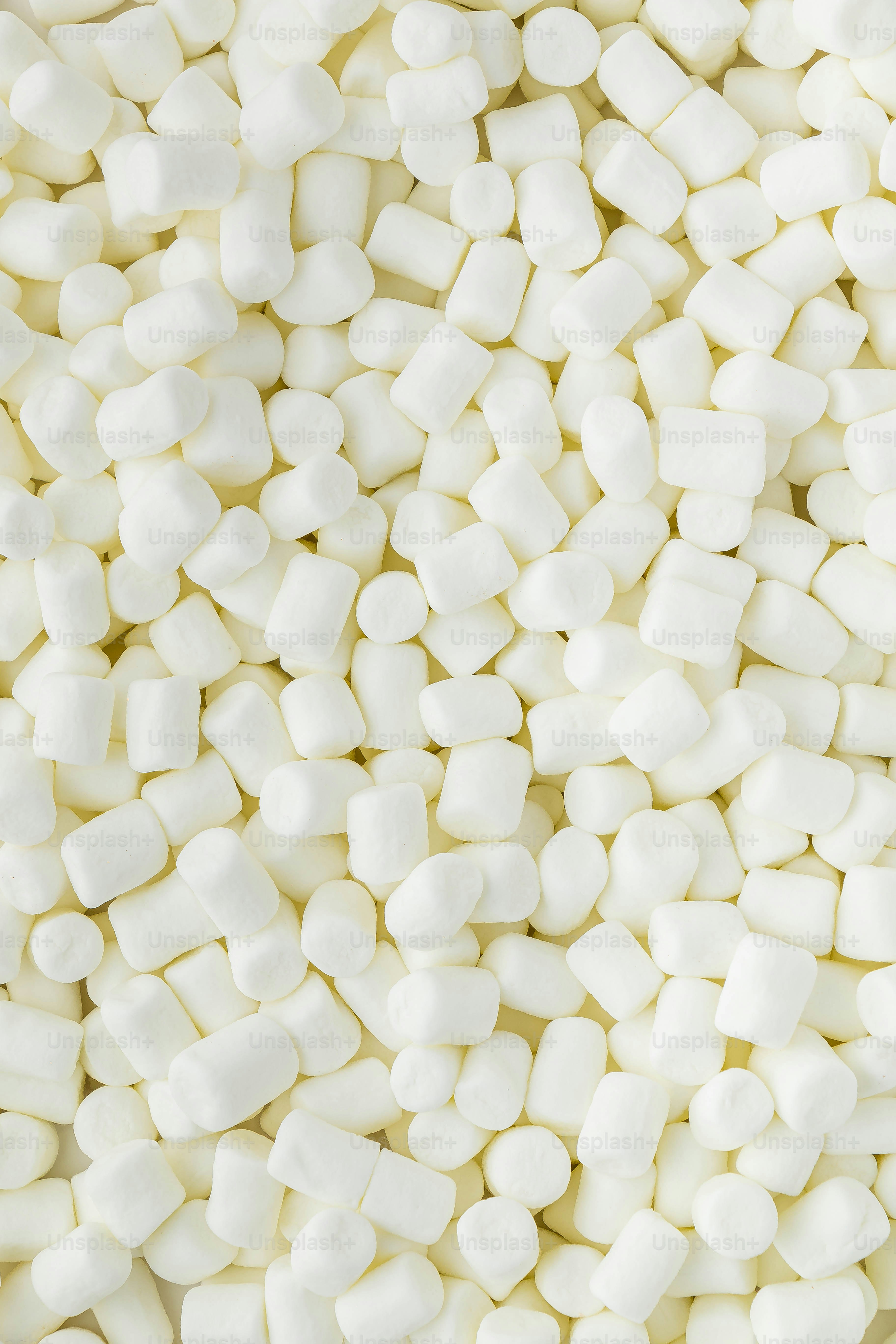 A pile of white marshmallows sitting on top of each other photo – Candy ...