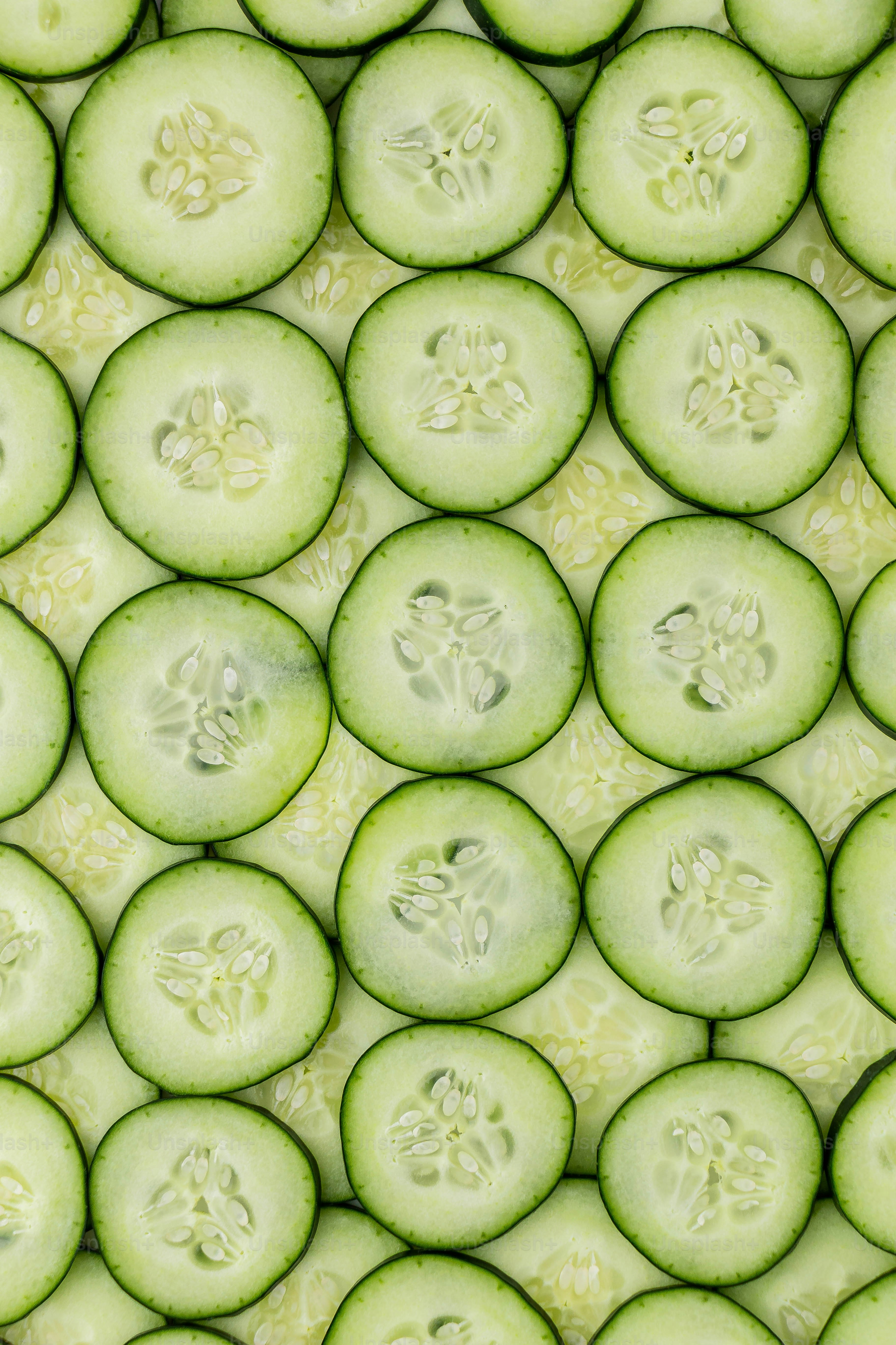A bunch of cucumbers that have been cut in half photo – Texture Image ...