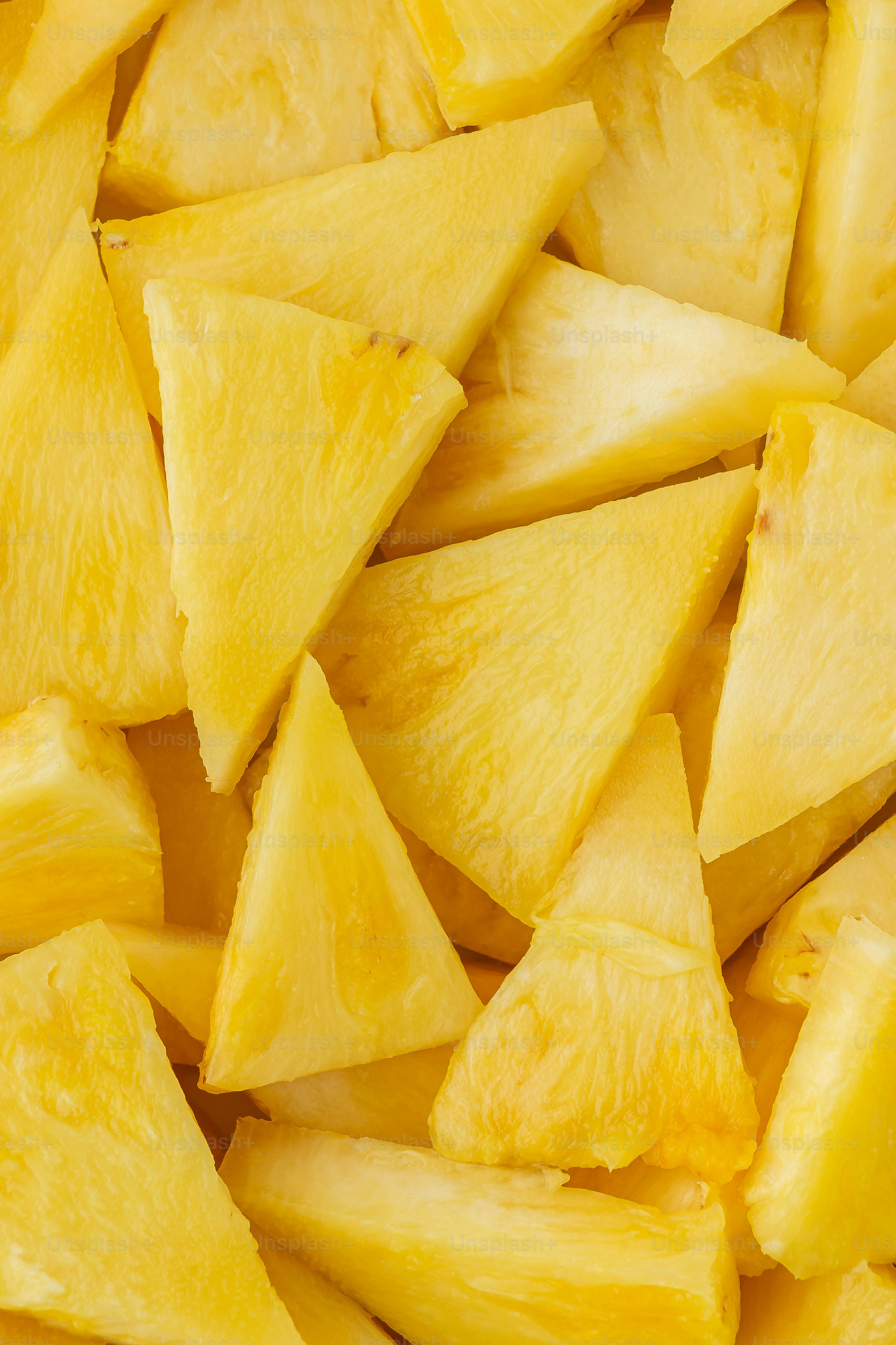 A pile of cut up pineapples sitting next to each other photo – Texture ...