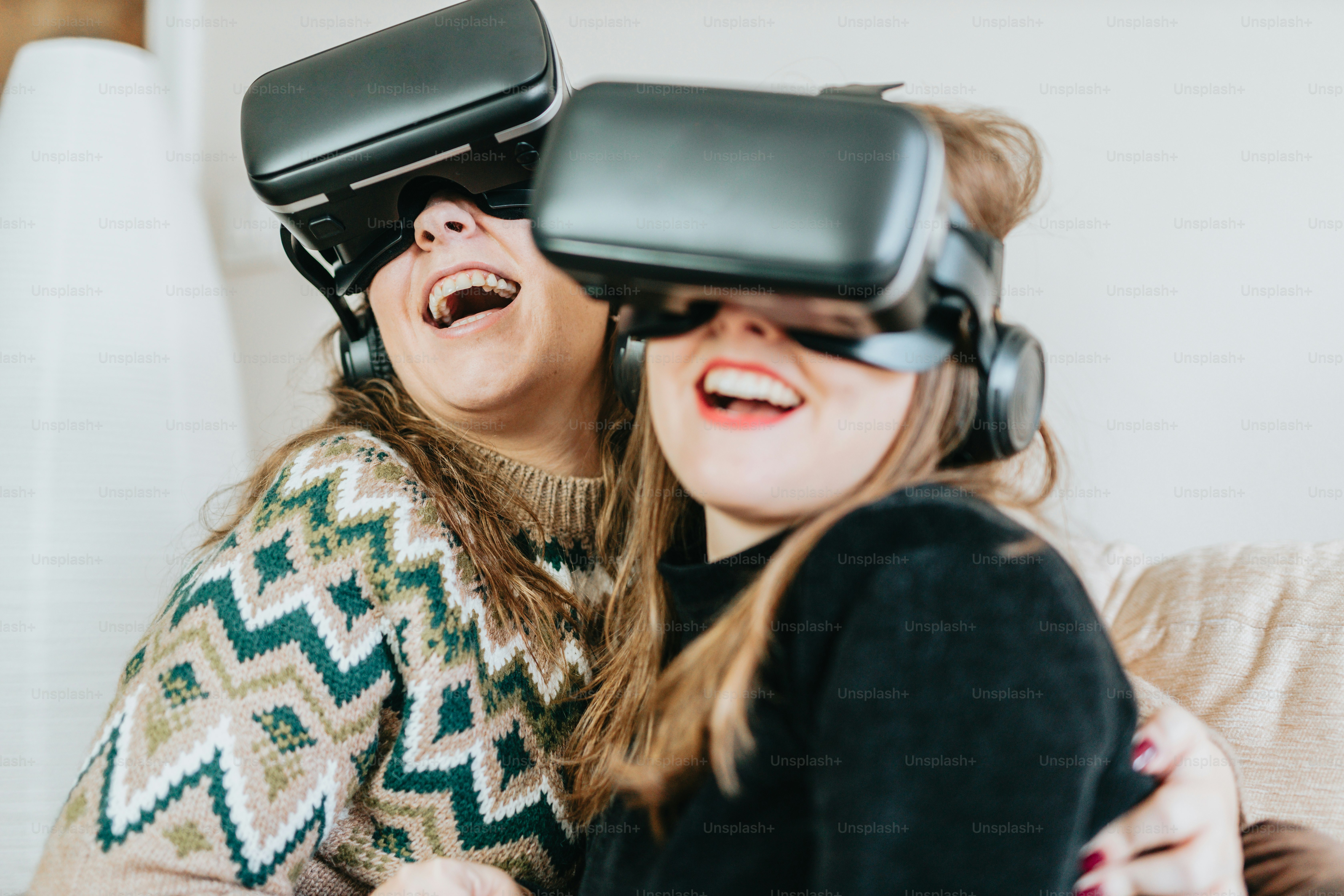 Two women sitting on a couch wearing virtual headsets photo – Virtual reality Image on Unsplash