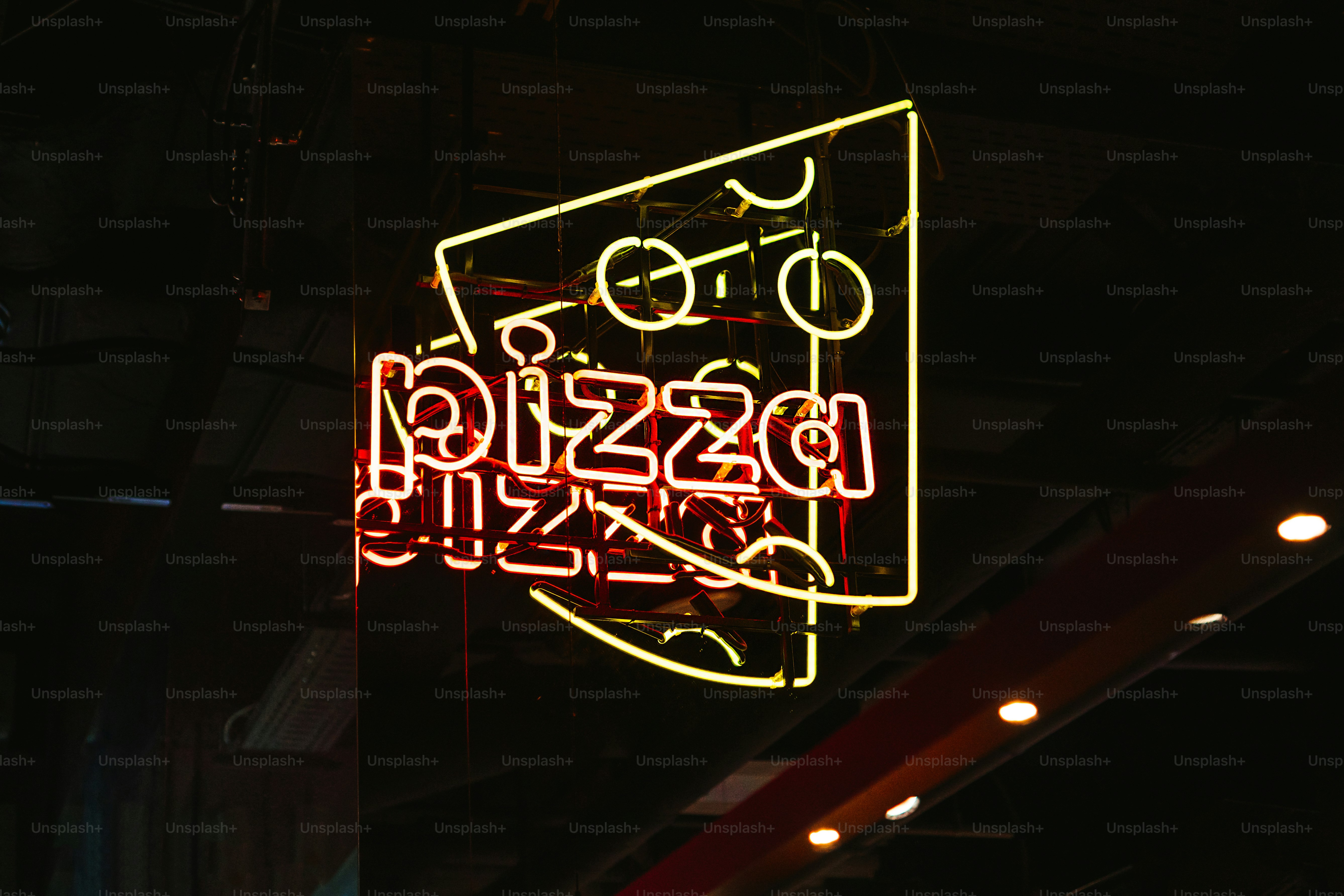 A neon sign hanging from the side of a building photo – Street ...