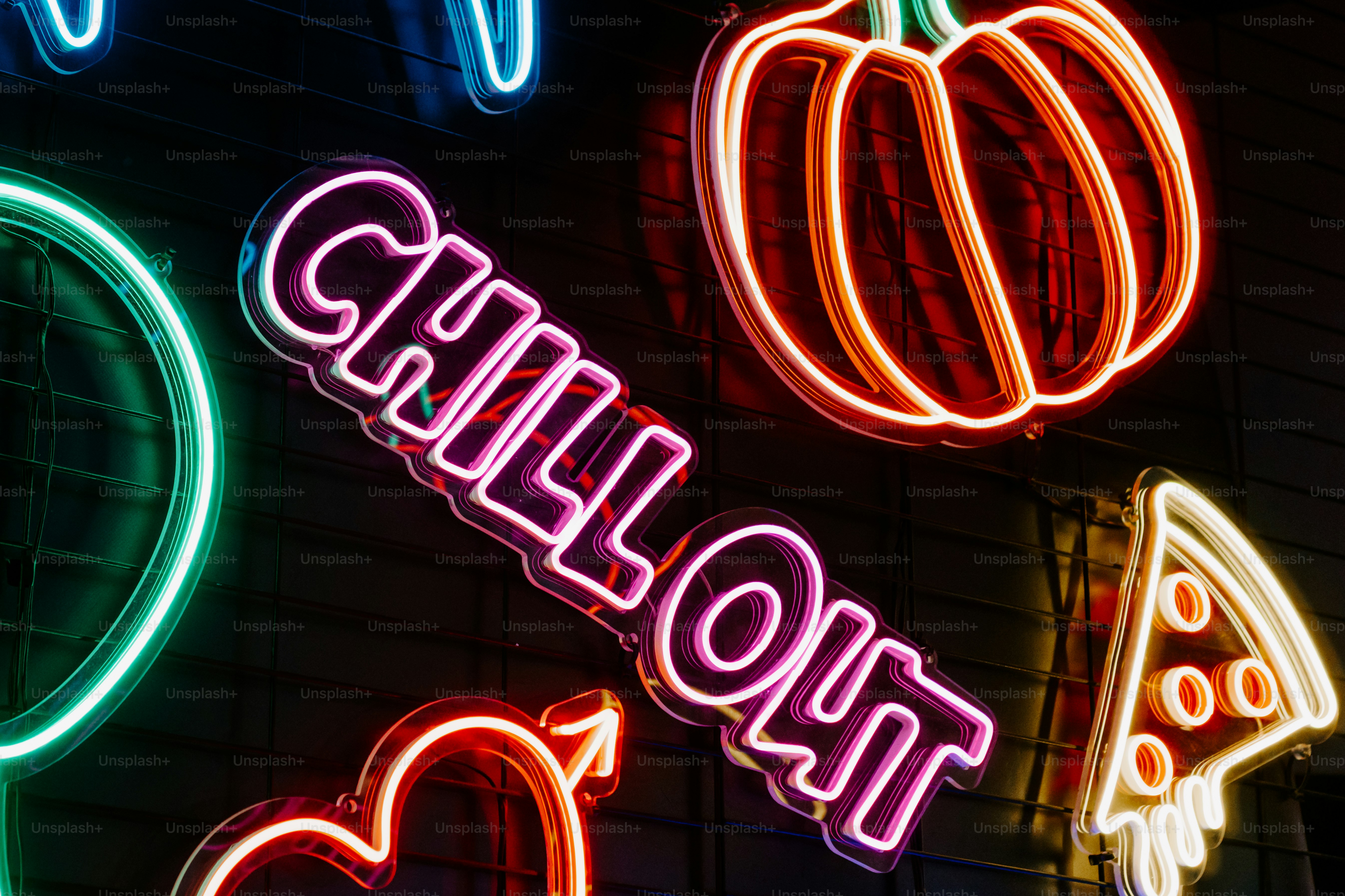 A bunch of neon signs hanging from the side of a building photo – Neon ...