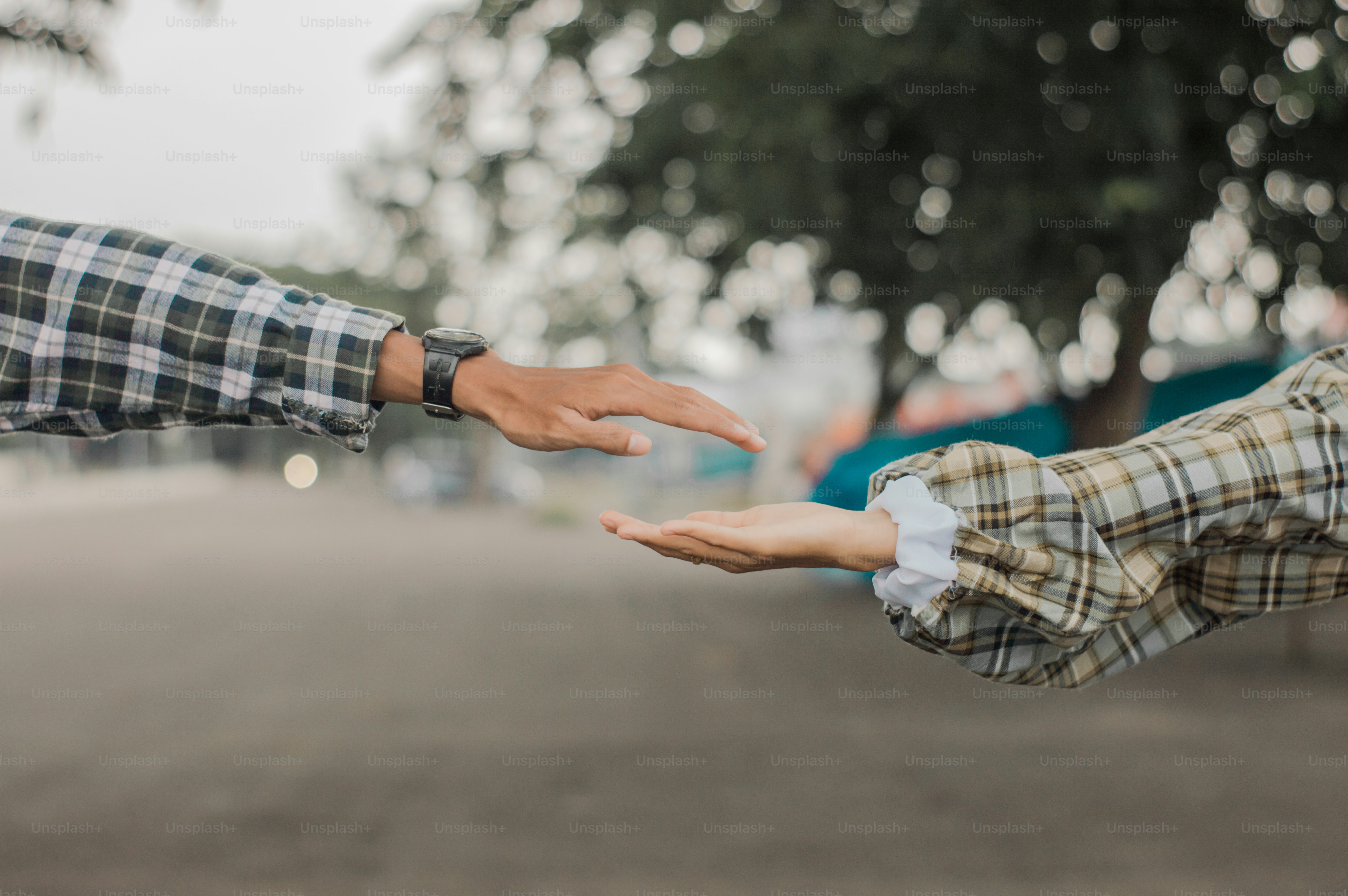 Two people reaching out their hands to each other photo – Couple Image ...