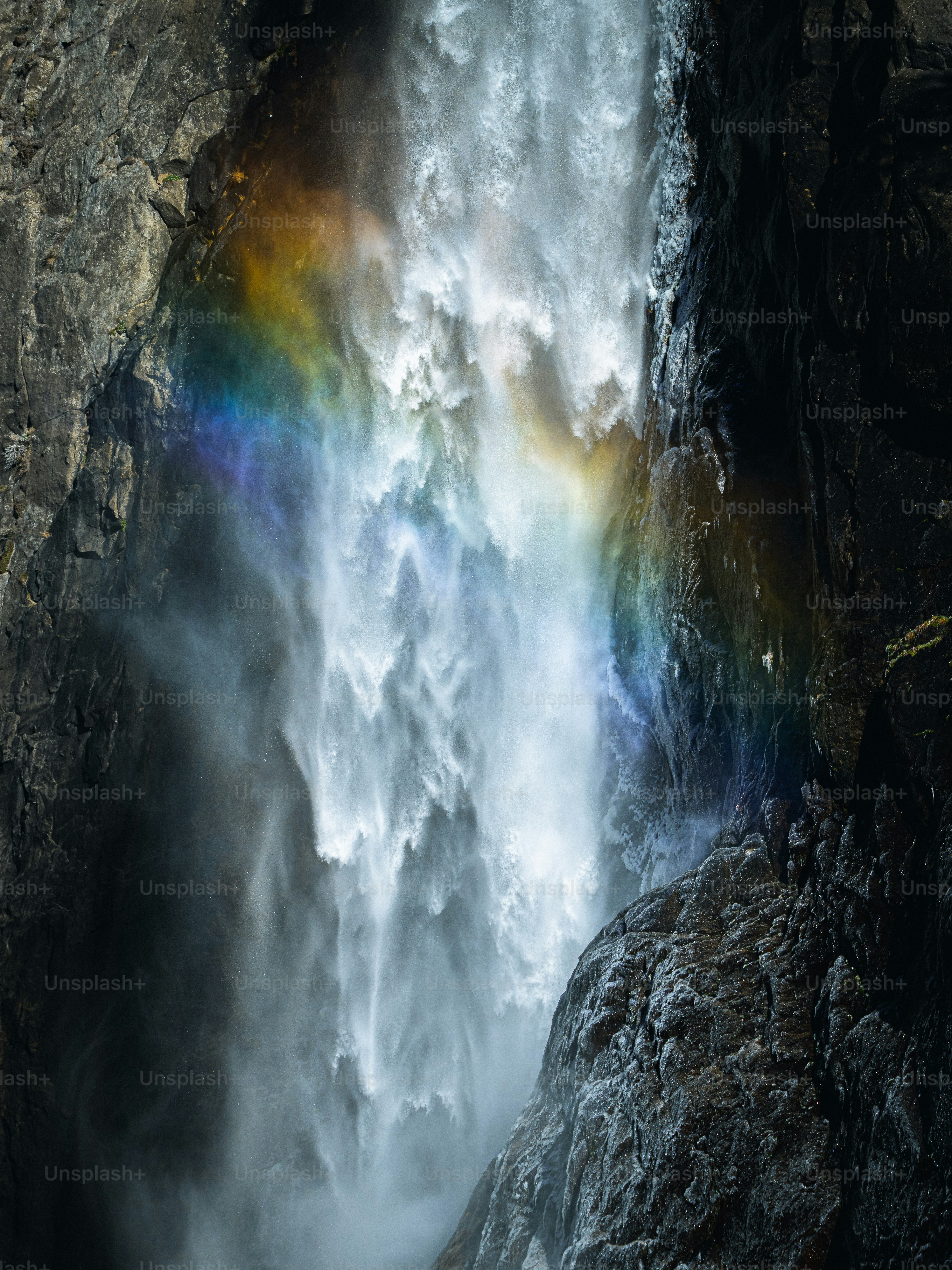 A waterfall with a rainbow in the middle of it photo – Waterfall Image ...