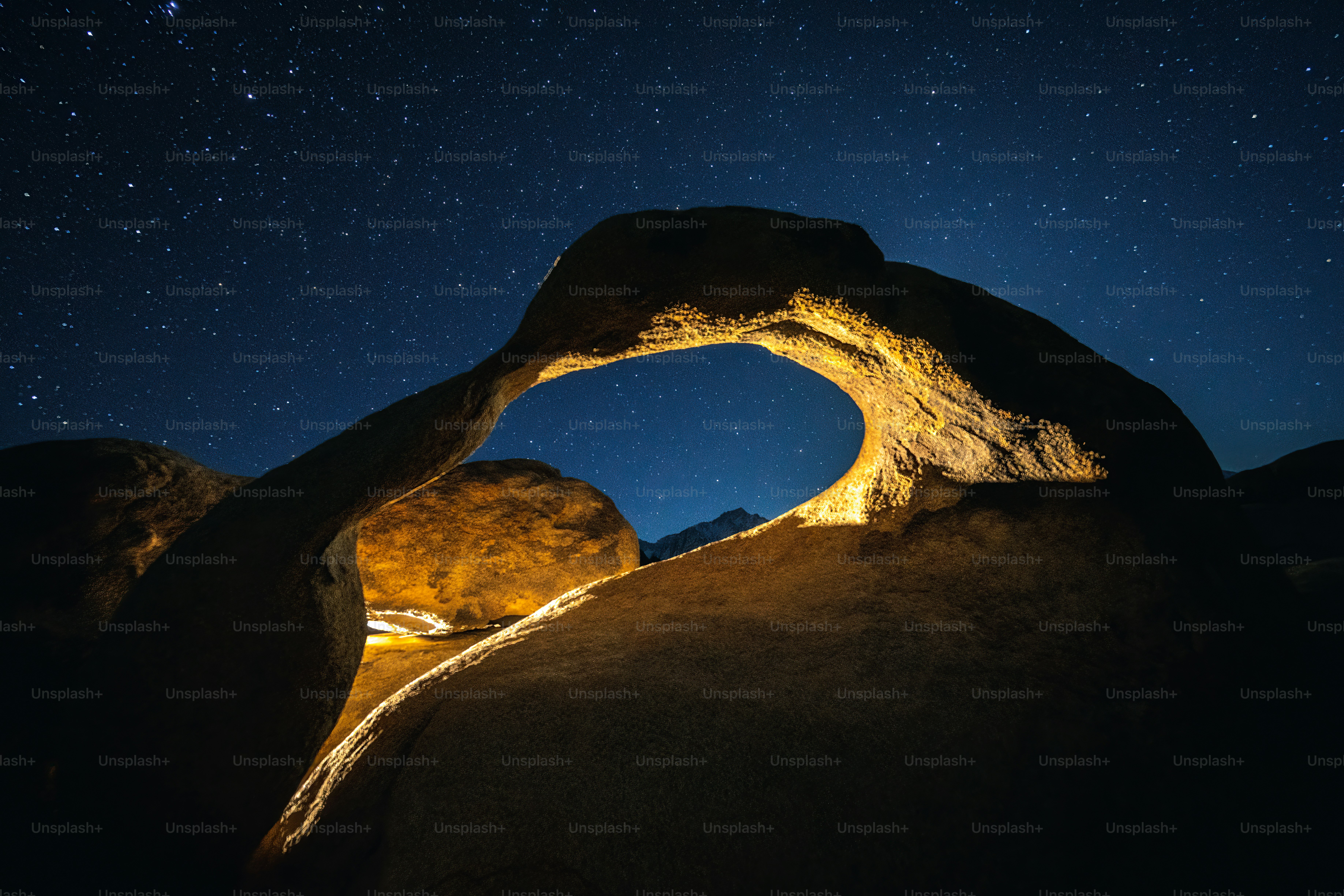 A rock formation with a hole in the middle of it photo – Screensaver ...
