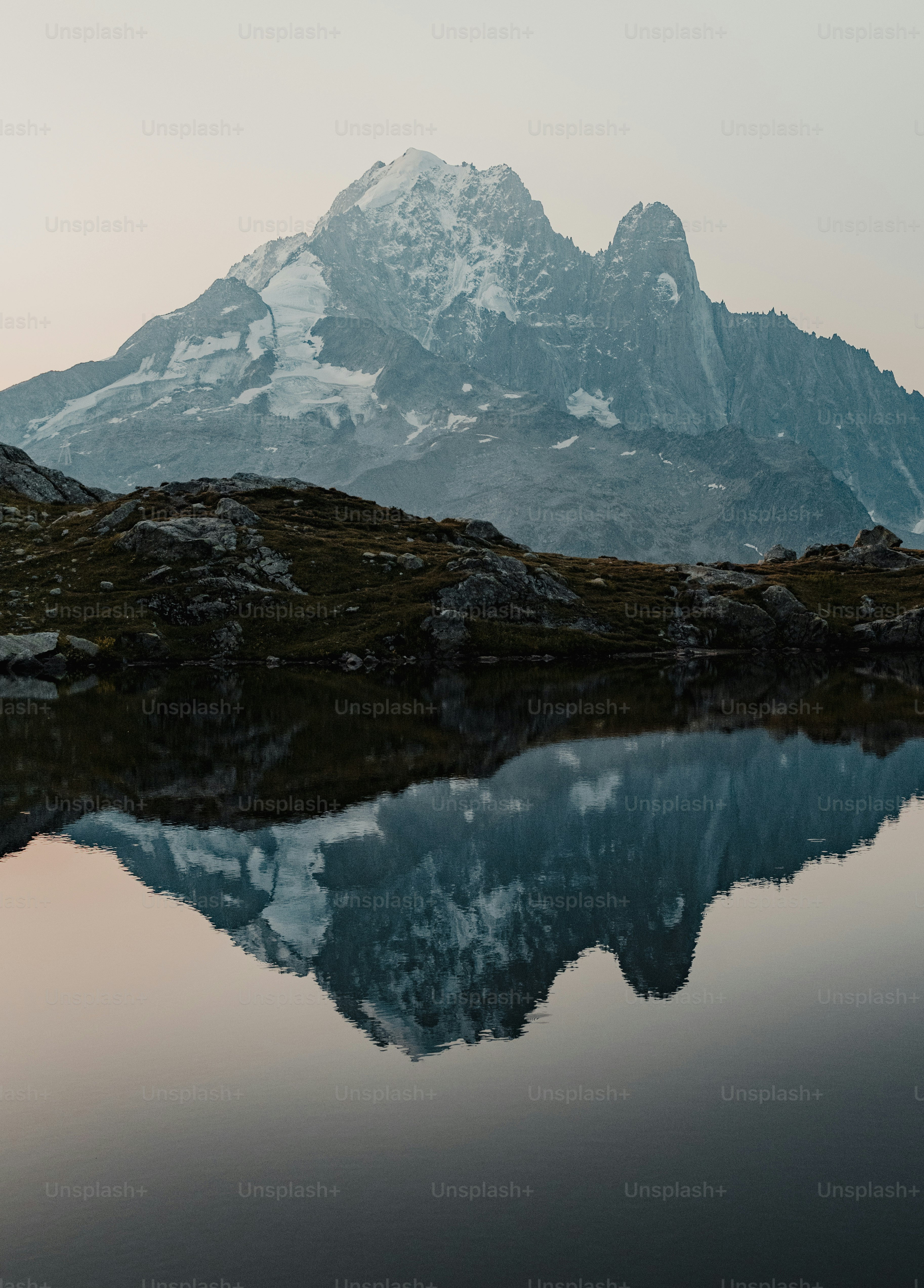 A view of a mountain range with trees in the foreground photo ...