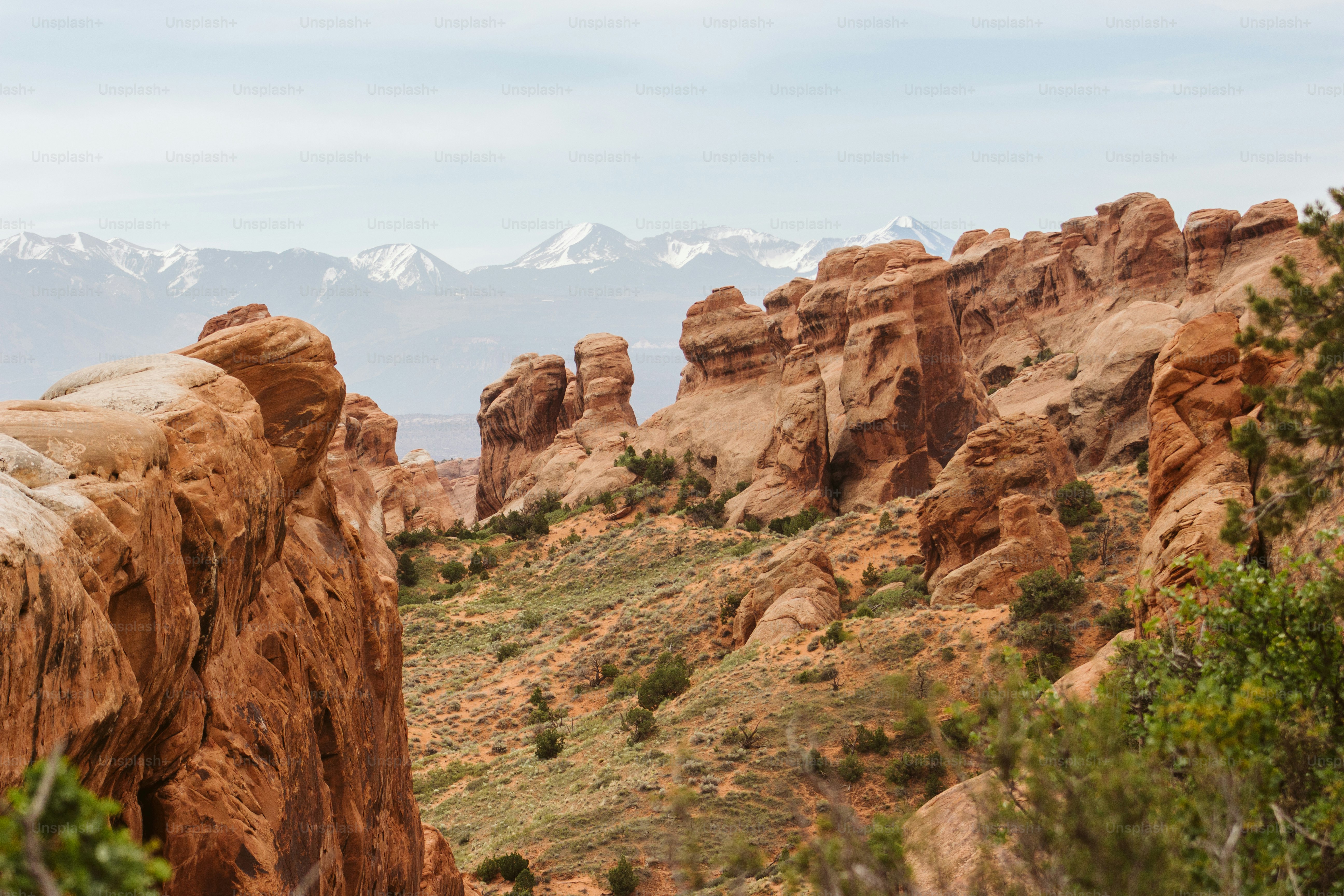 A large rock formation with a bridge in the middle of it photo ...