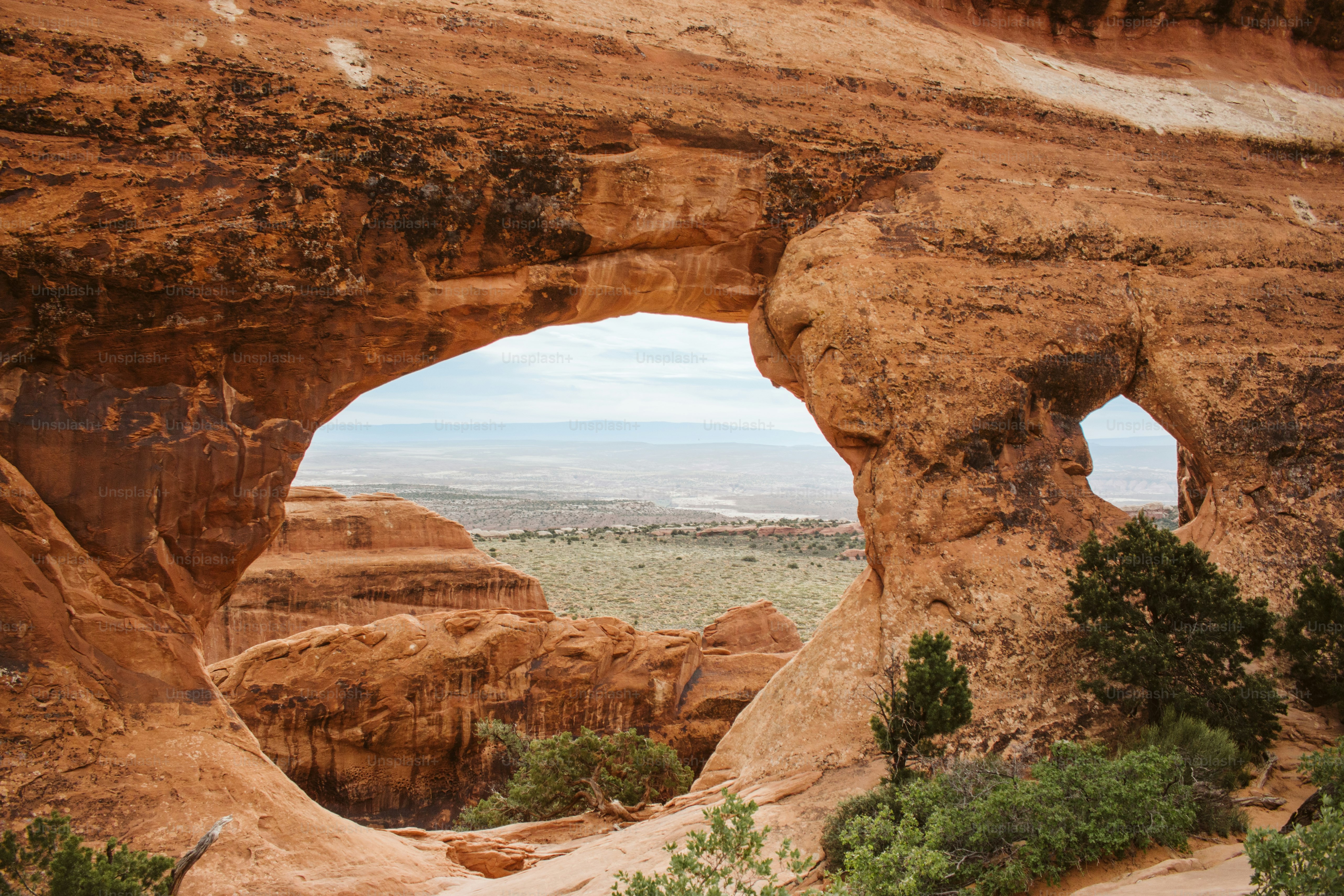 A large rock formation with a bridge in the middle of it photo – Canyon ...