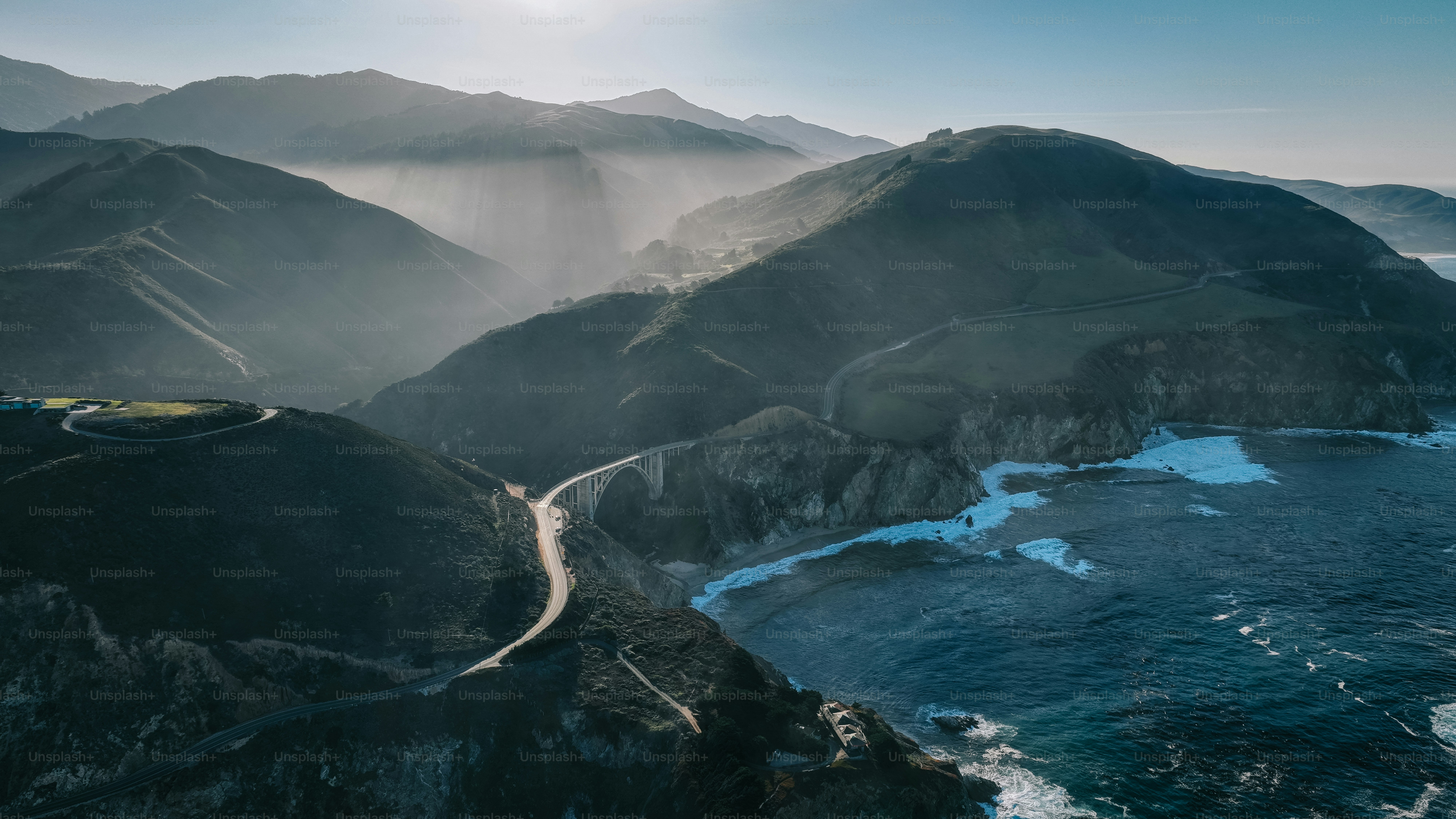 An aerial view of a winding road near the ocean photo – Usa Image on ...