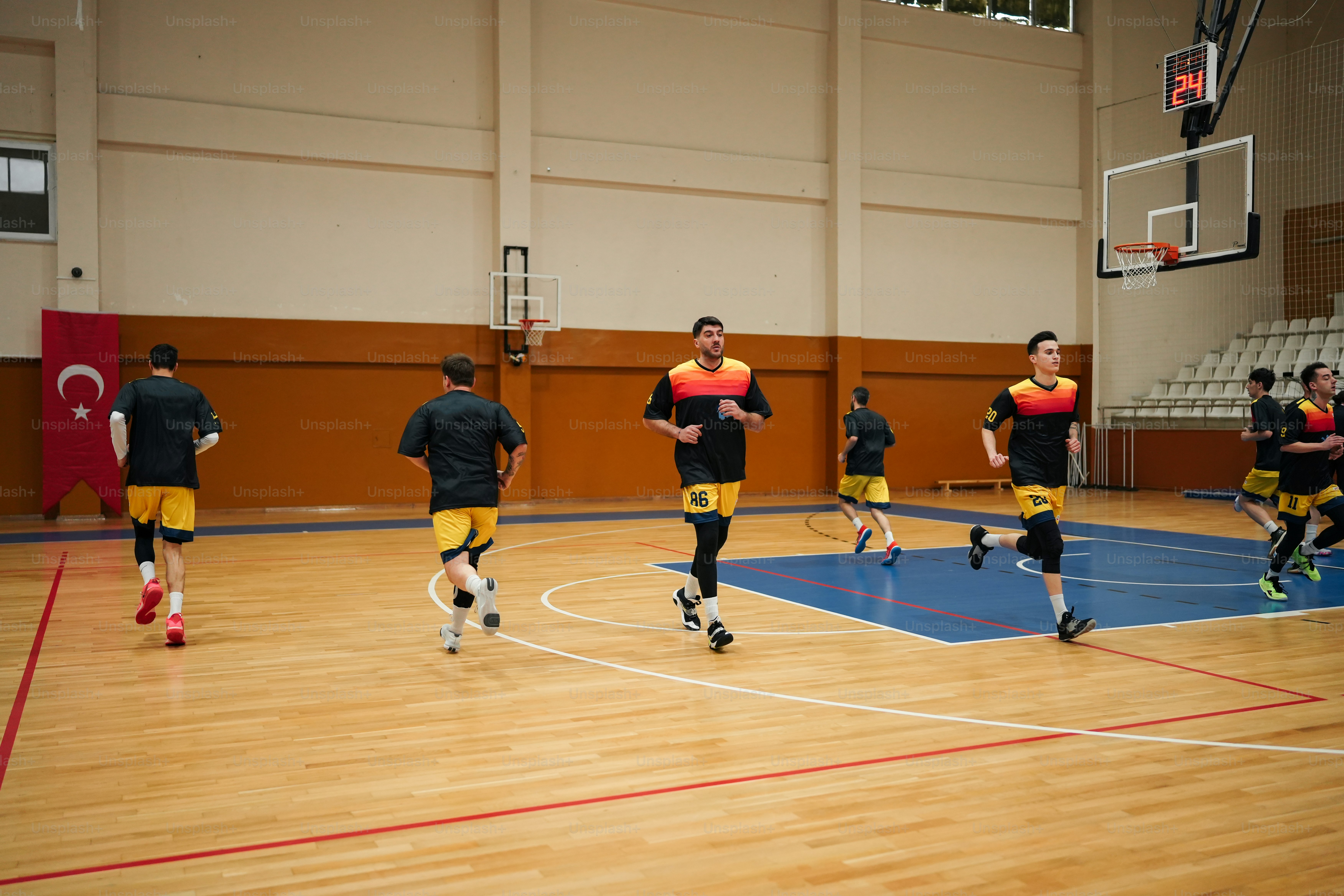 A group of young men playing a game of basketball photo – Join Image on ...