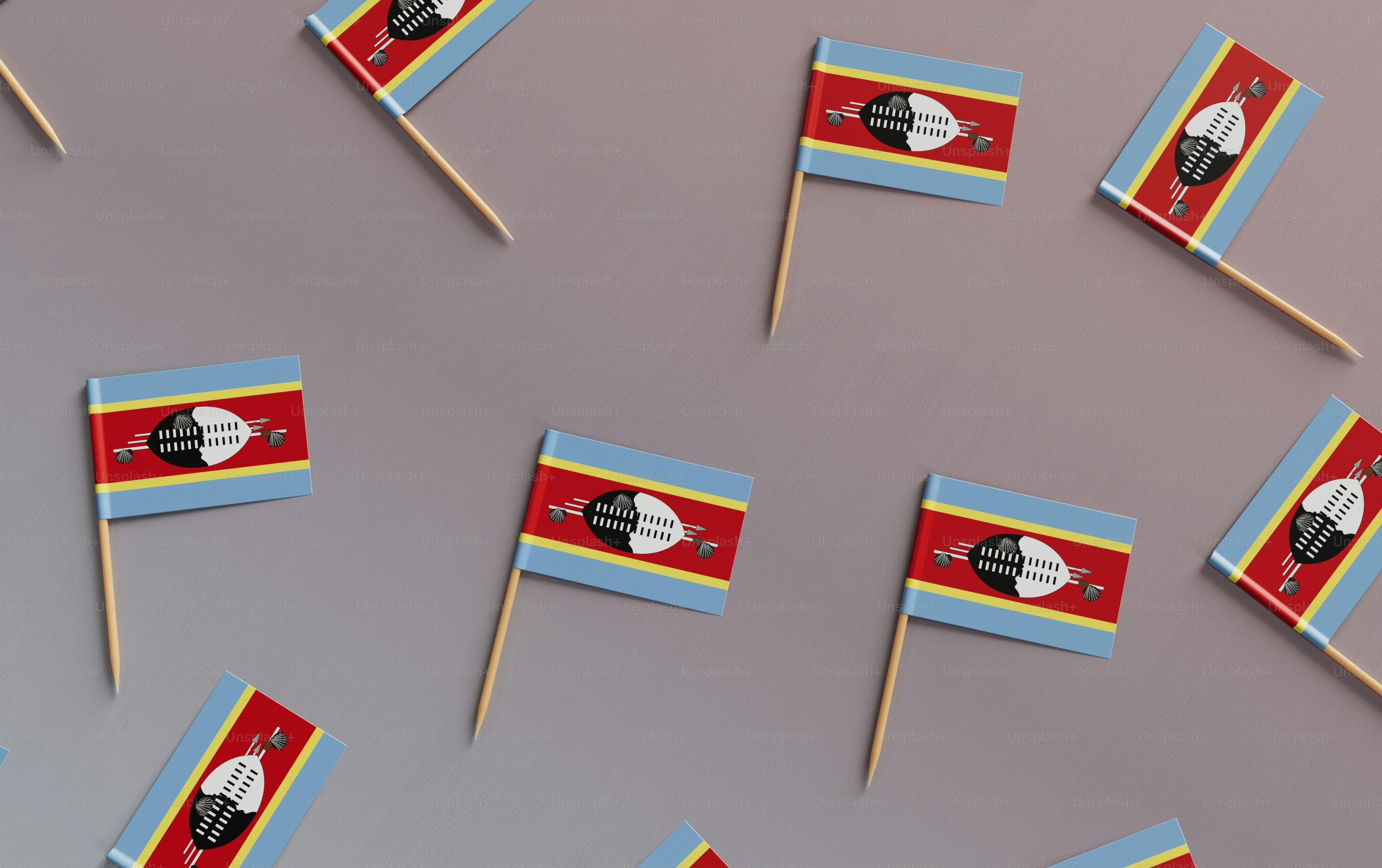 A group of small flags sitting on top of a table photo – Flags Image on ...