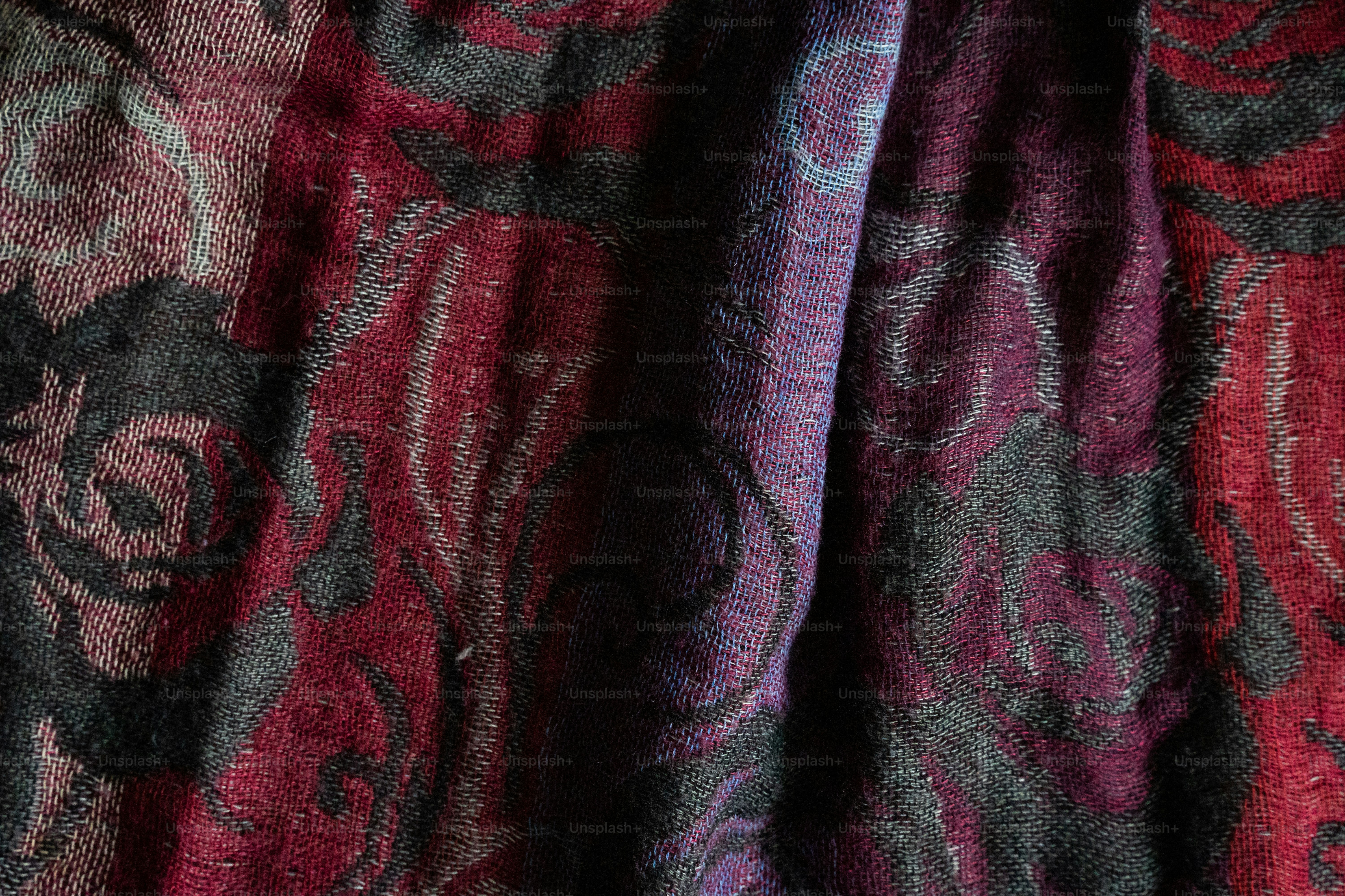 A close up of a red and black scarf photo – Texture Image on Unsplash