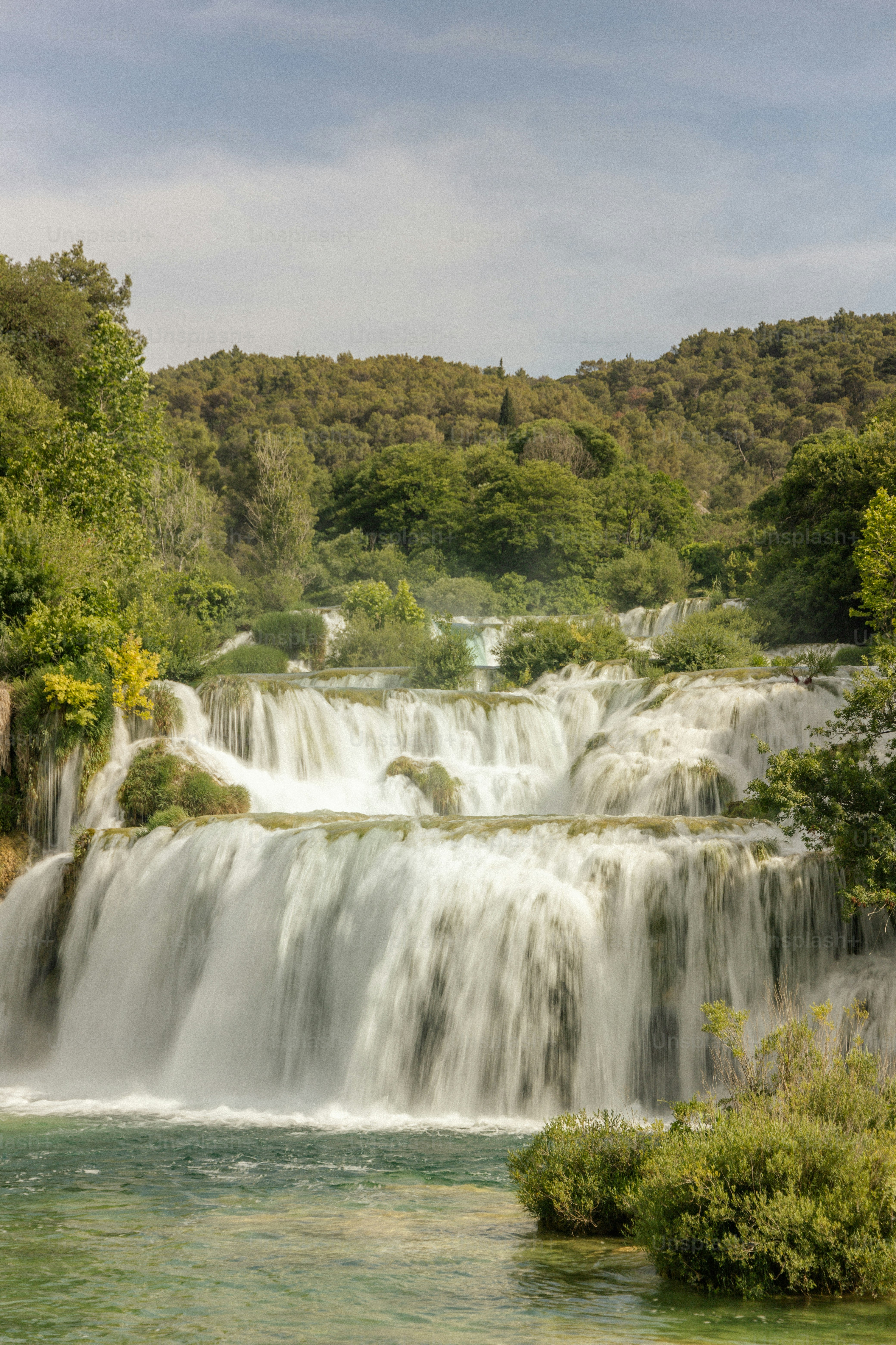 A group of people standing in front of a waterfall photo – Nature ...