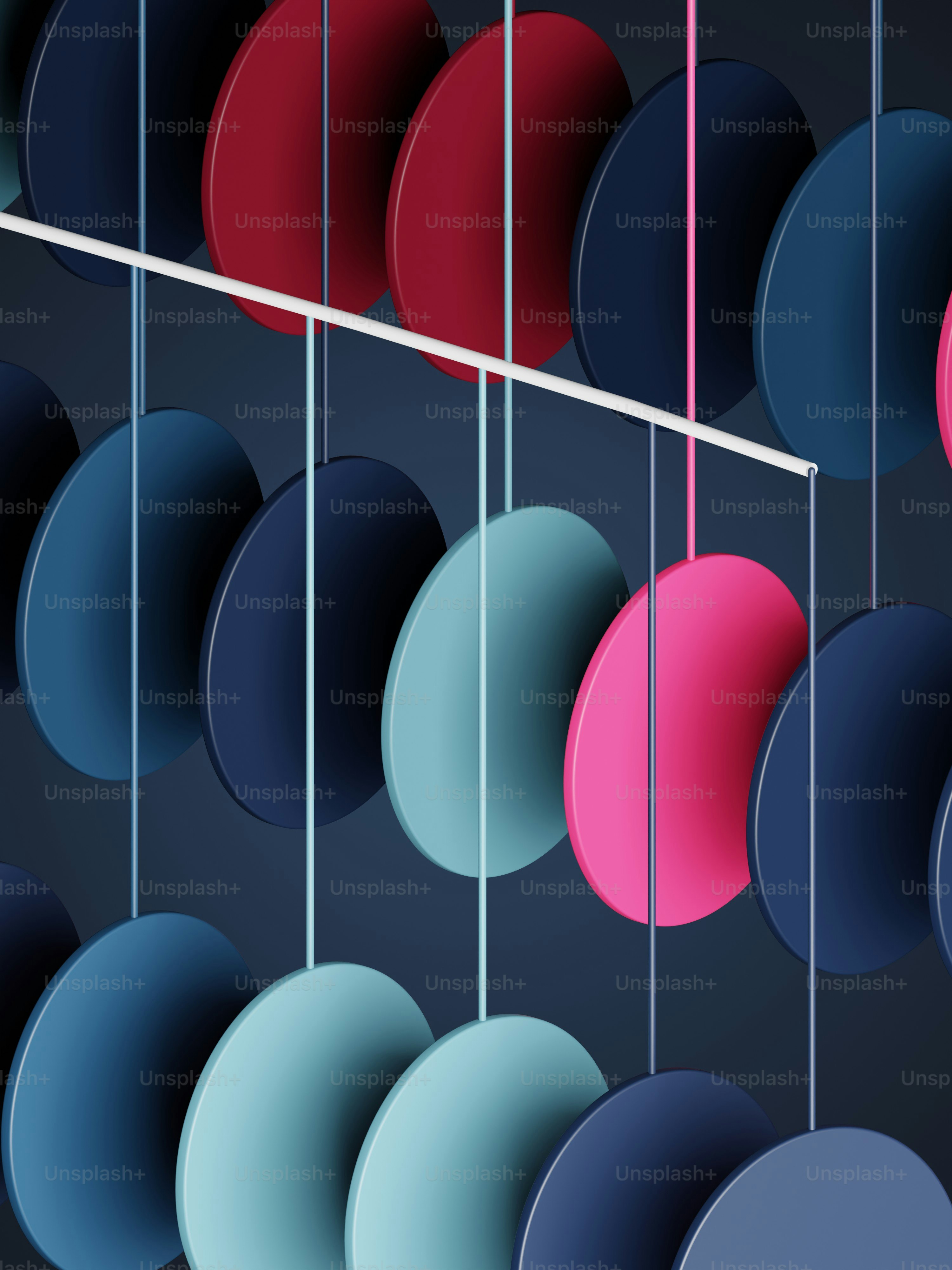 A group of colorful balls hanging from strings photo – Disk Image on ...