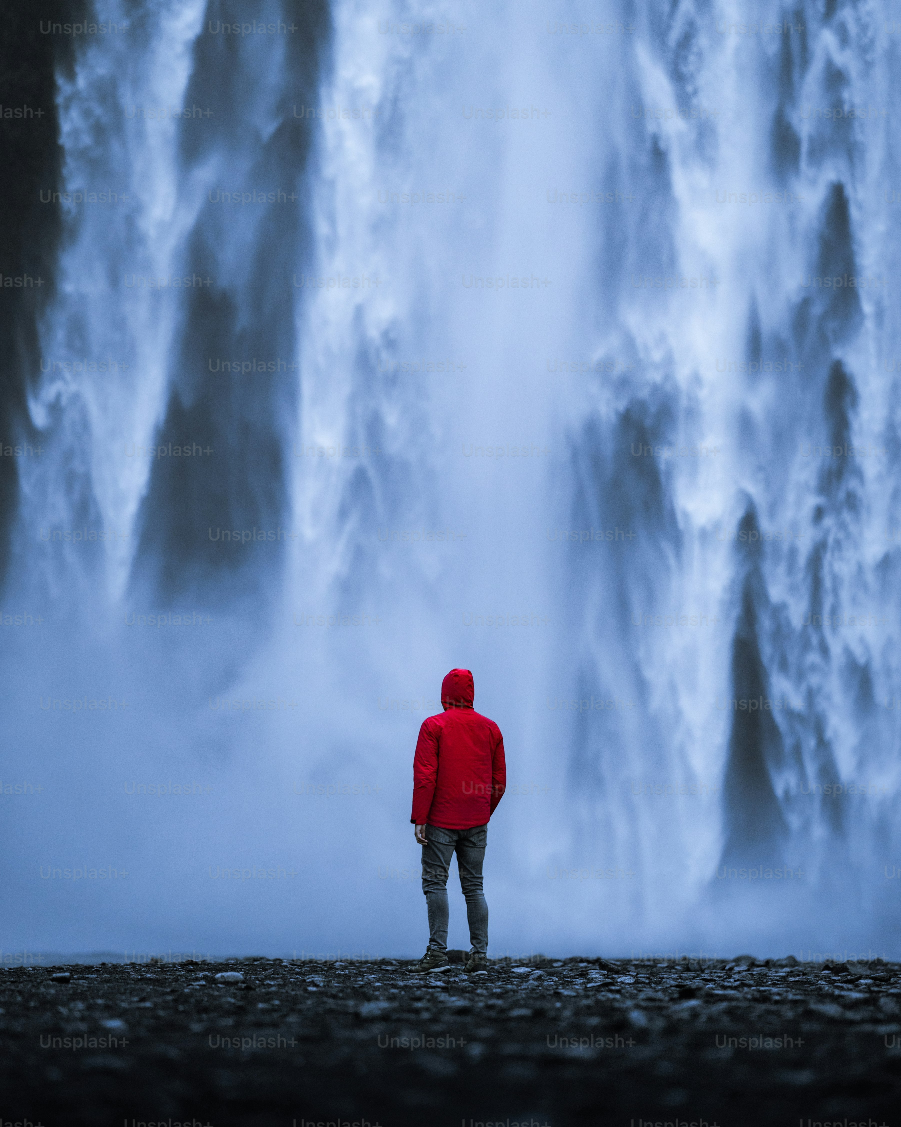 A person standing in front of a waterfall photo – Sad boy Image on Unsplash