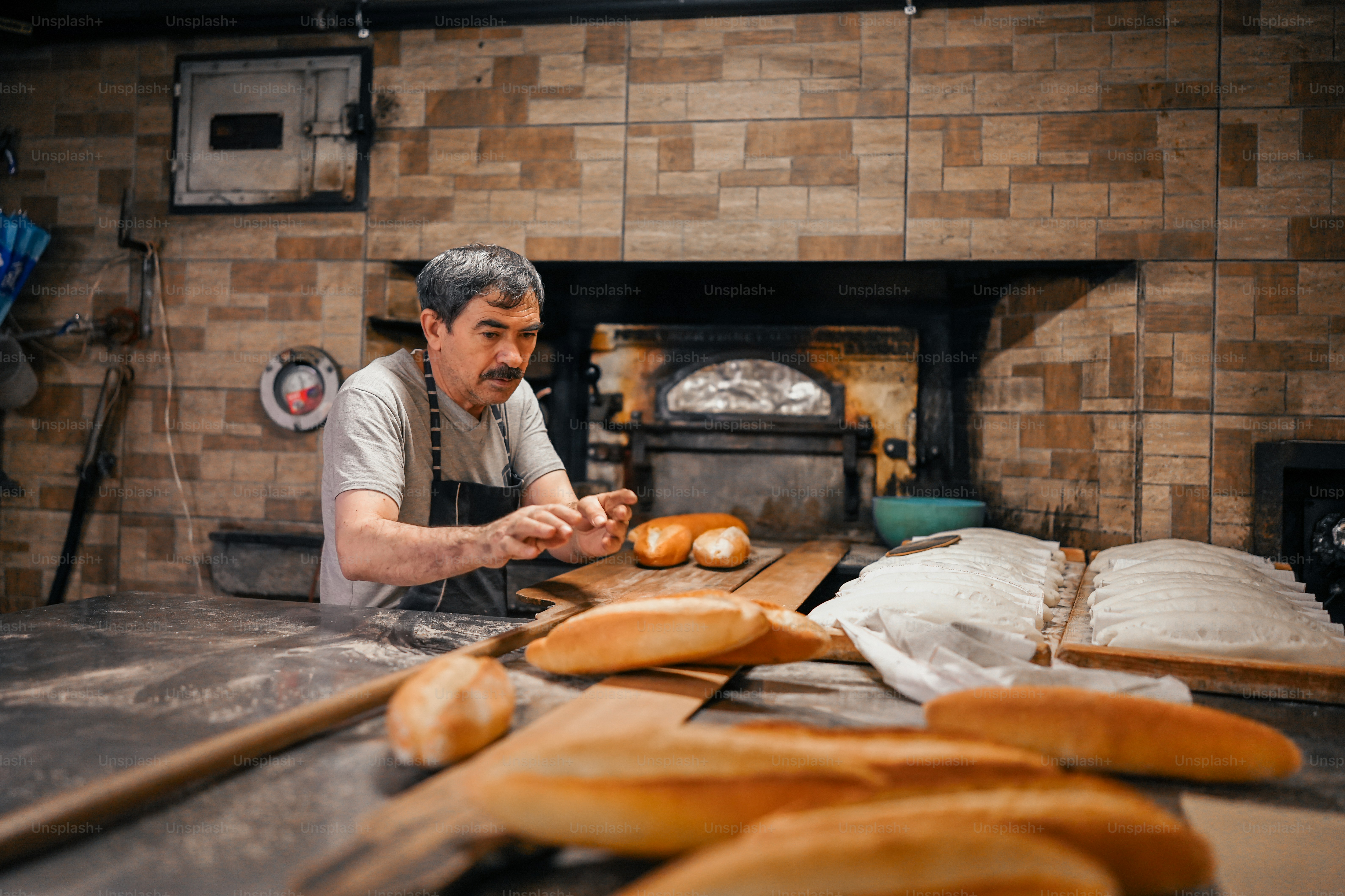 A man is making bread in a kitchen photo – Professional Image on Unsplash
