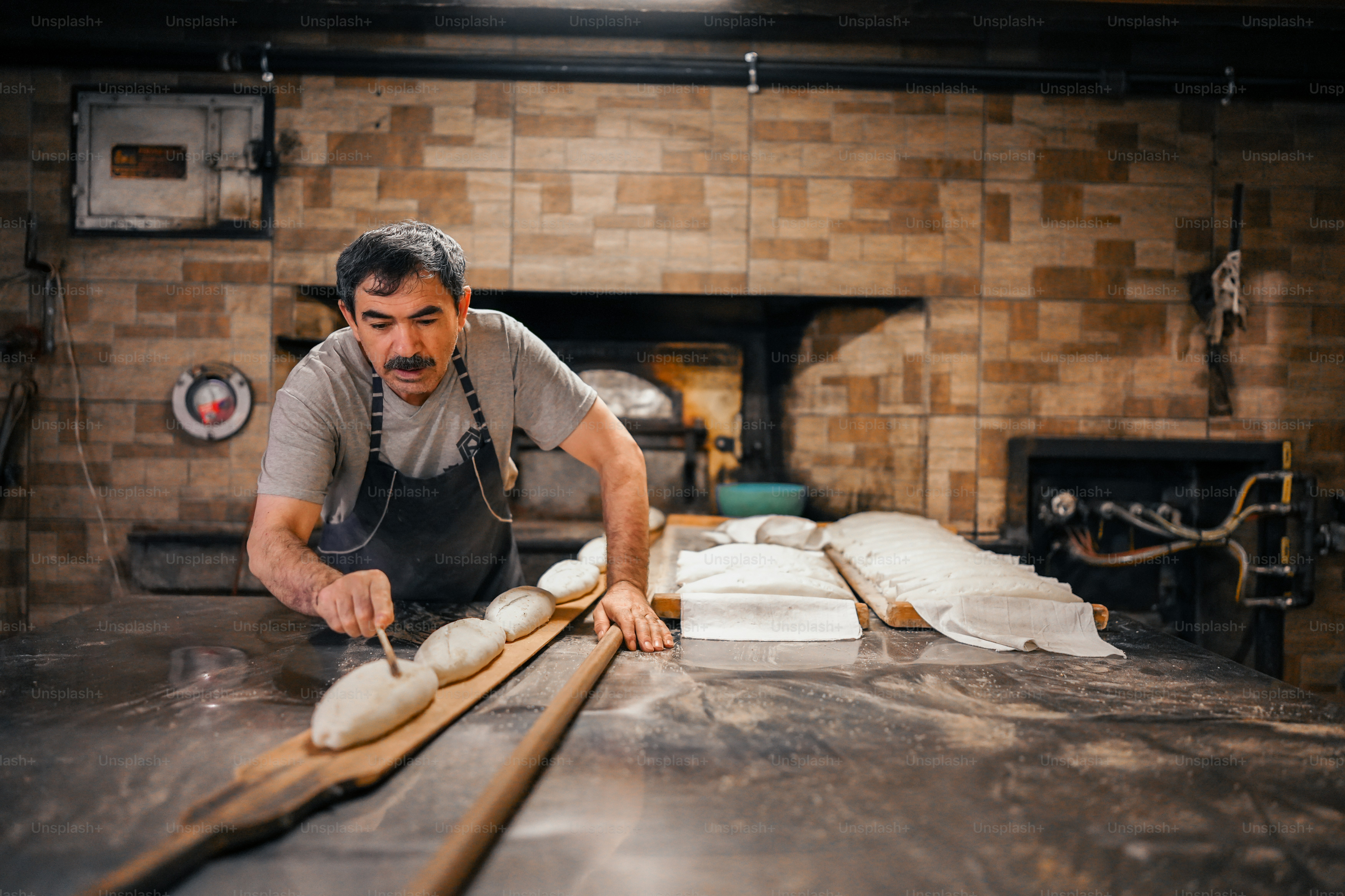 A bunch of breads that are on a shelf photo – Baking bread Image on ...
