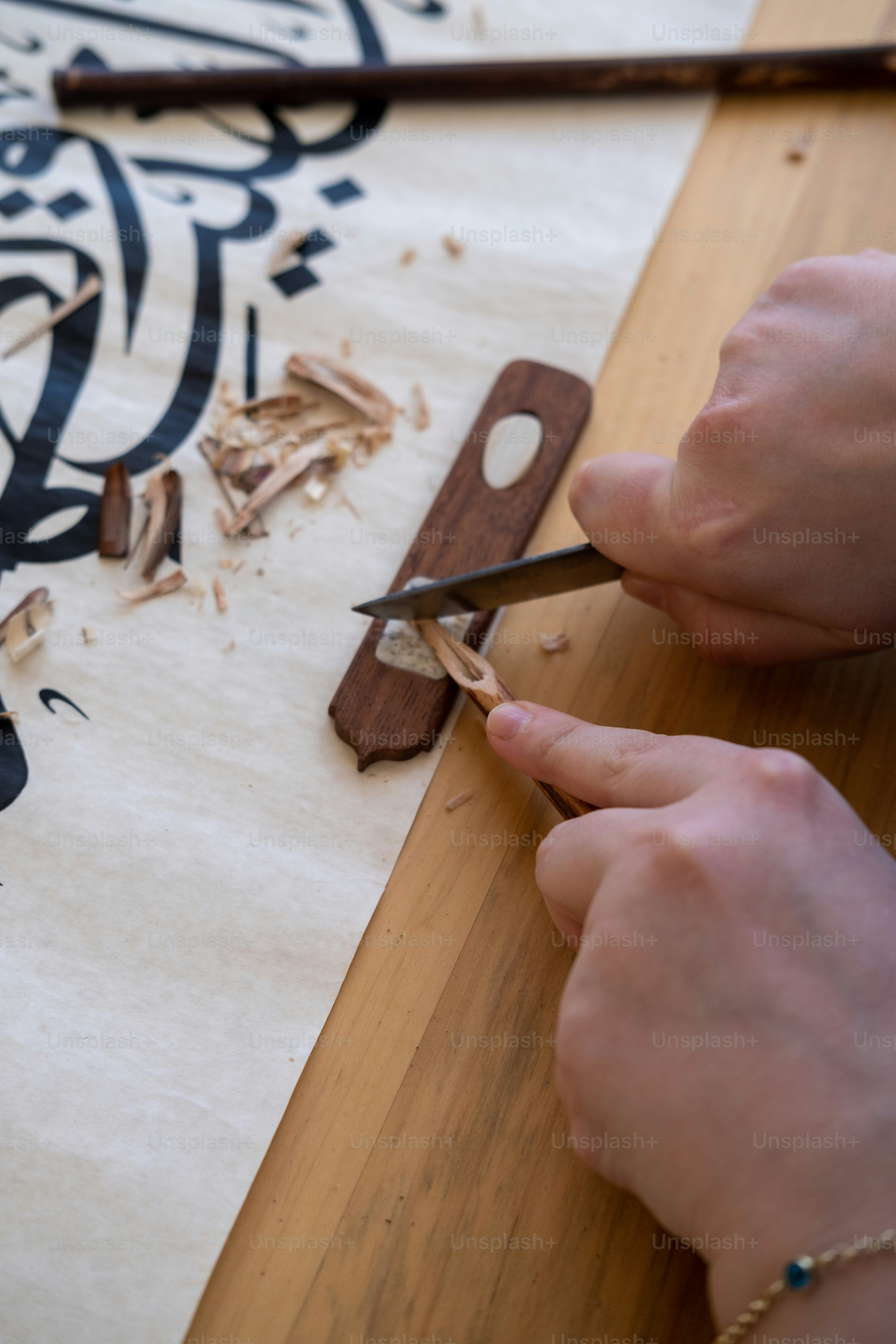 A person cutting wood with a pair of scissors photo – Script Image on ...