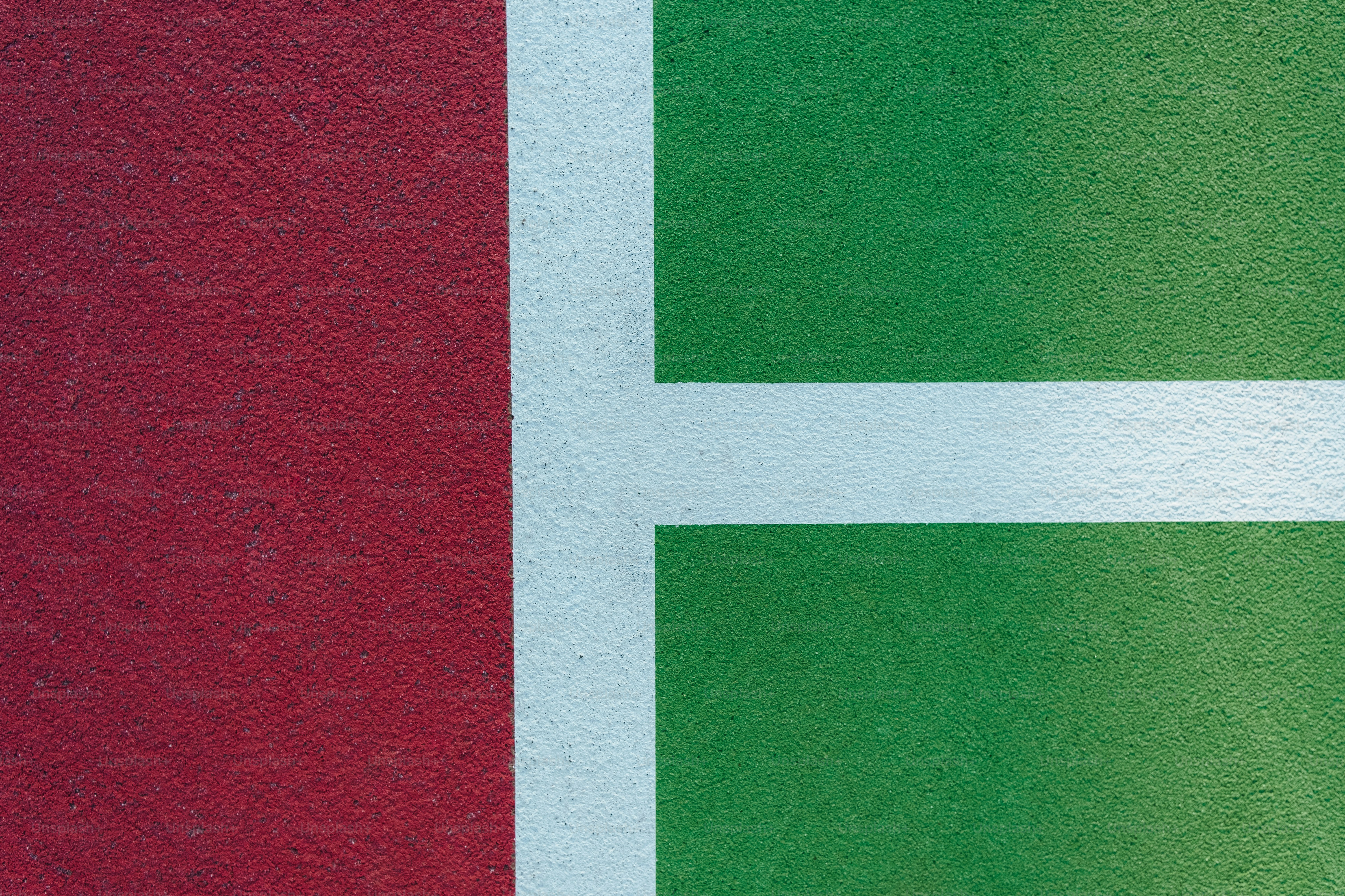 A red and green wall with a white stripe photo – Tennis court Image on ...