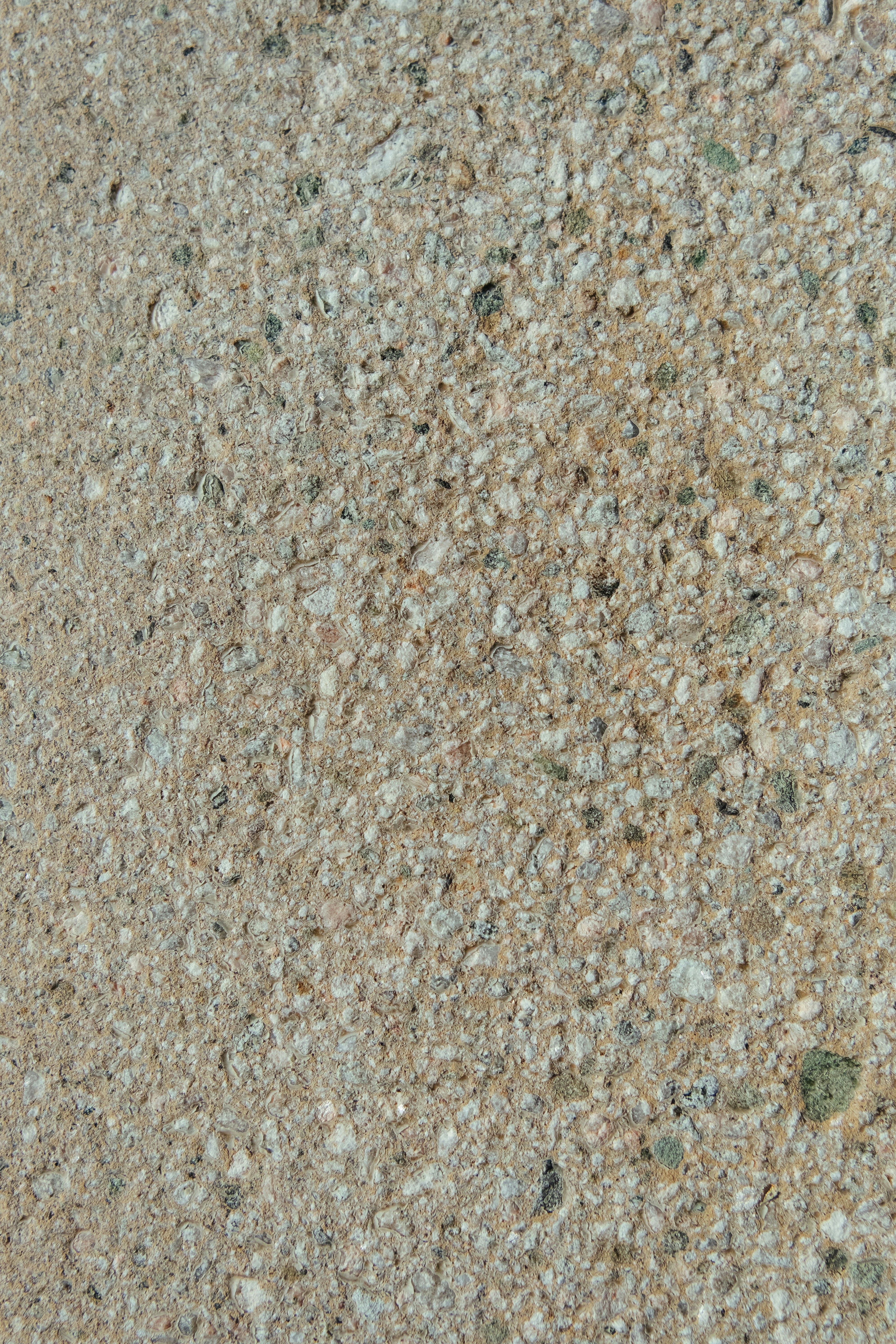 A close up of a stone surface with small rocks photo – Granite Image on ...