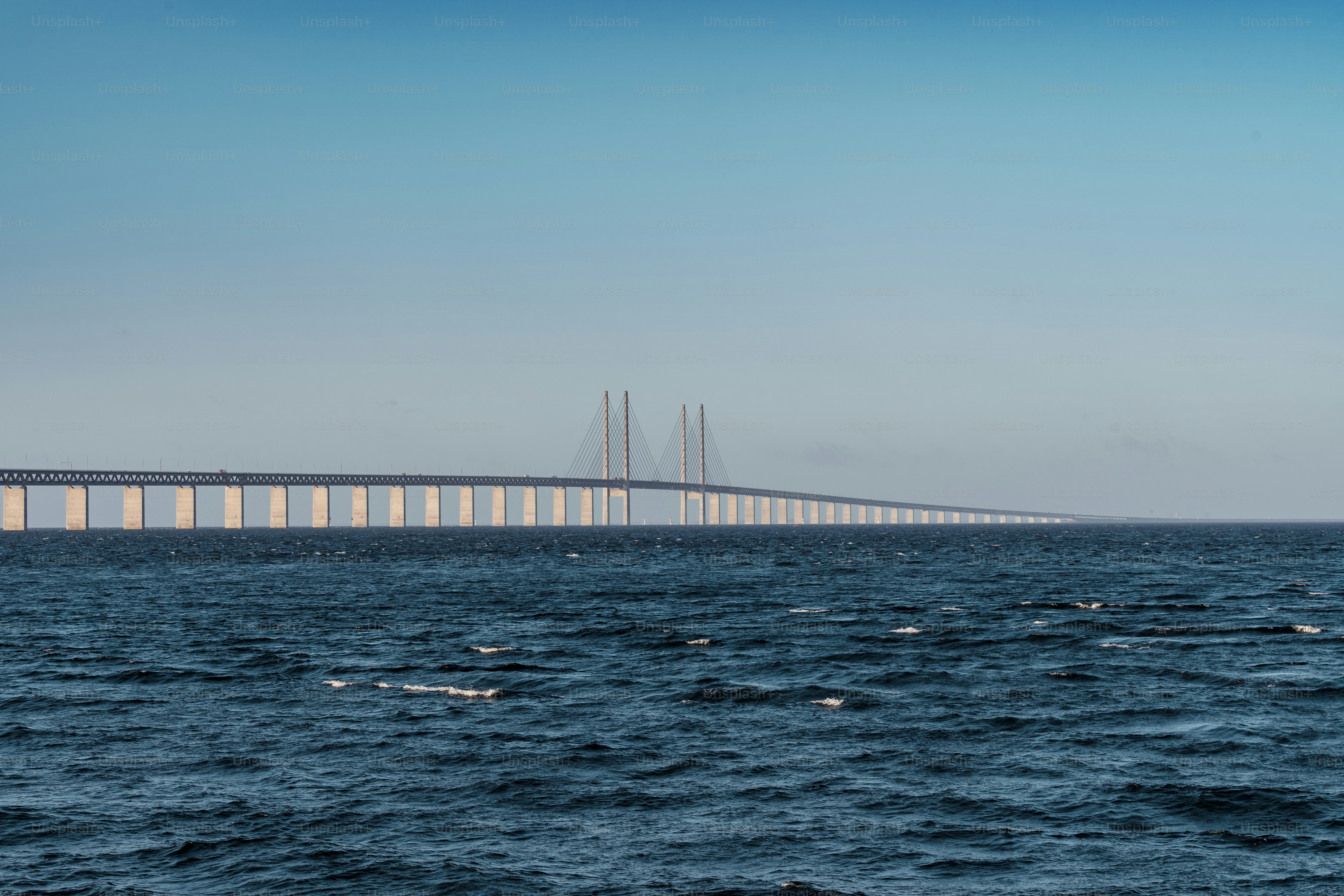 A large bridge spanning over a large body of water photo – Bridge Image ...