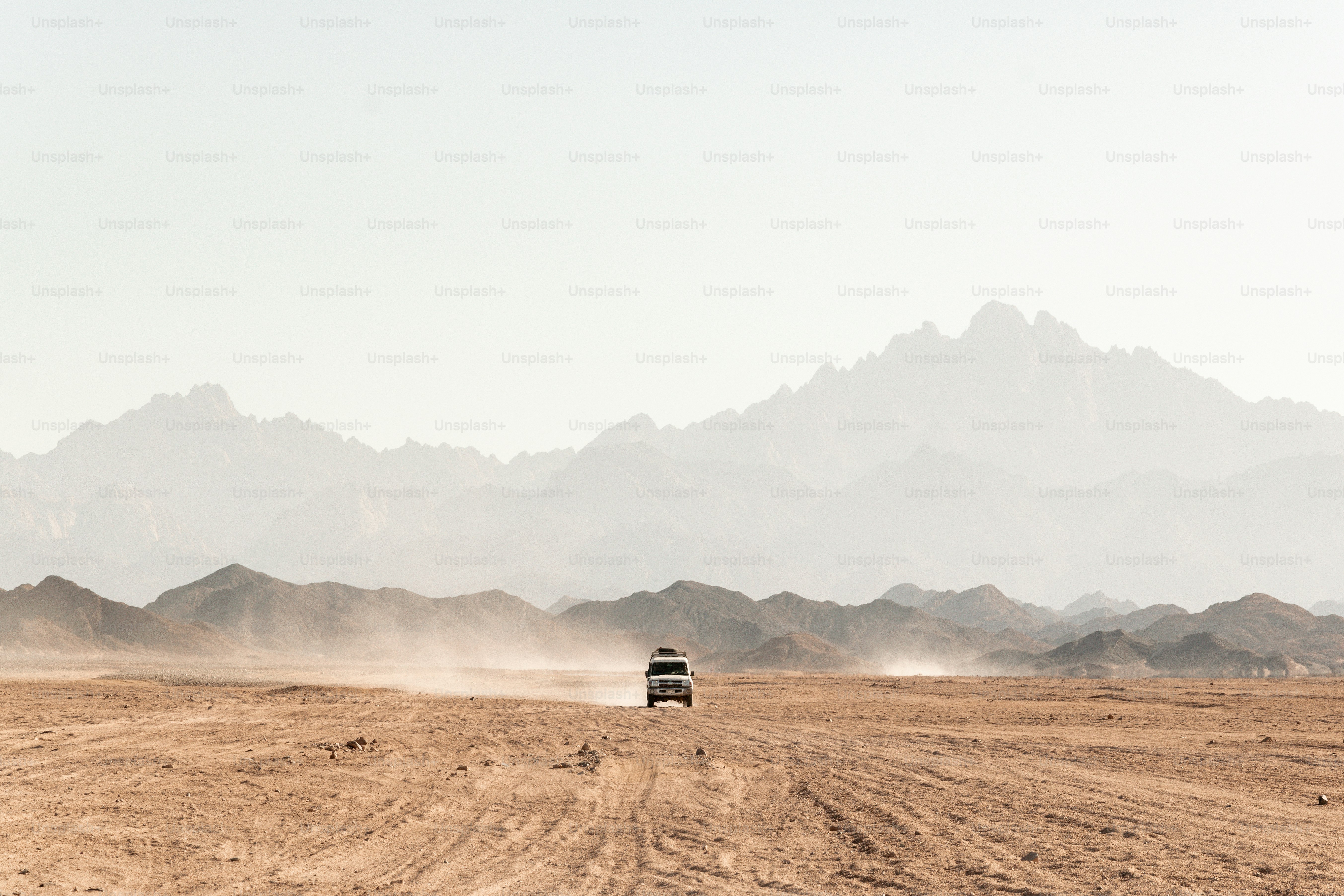 A truck driving down a dirt road in the desert photo – Egypt Image on ...