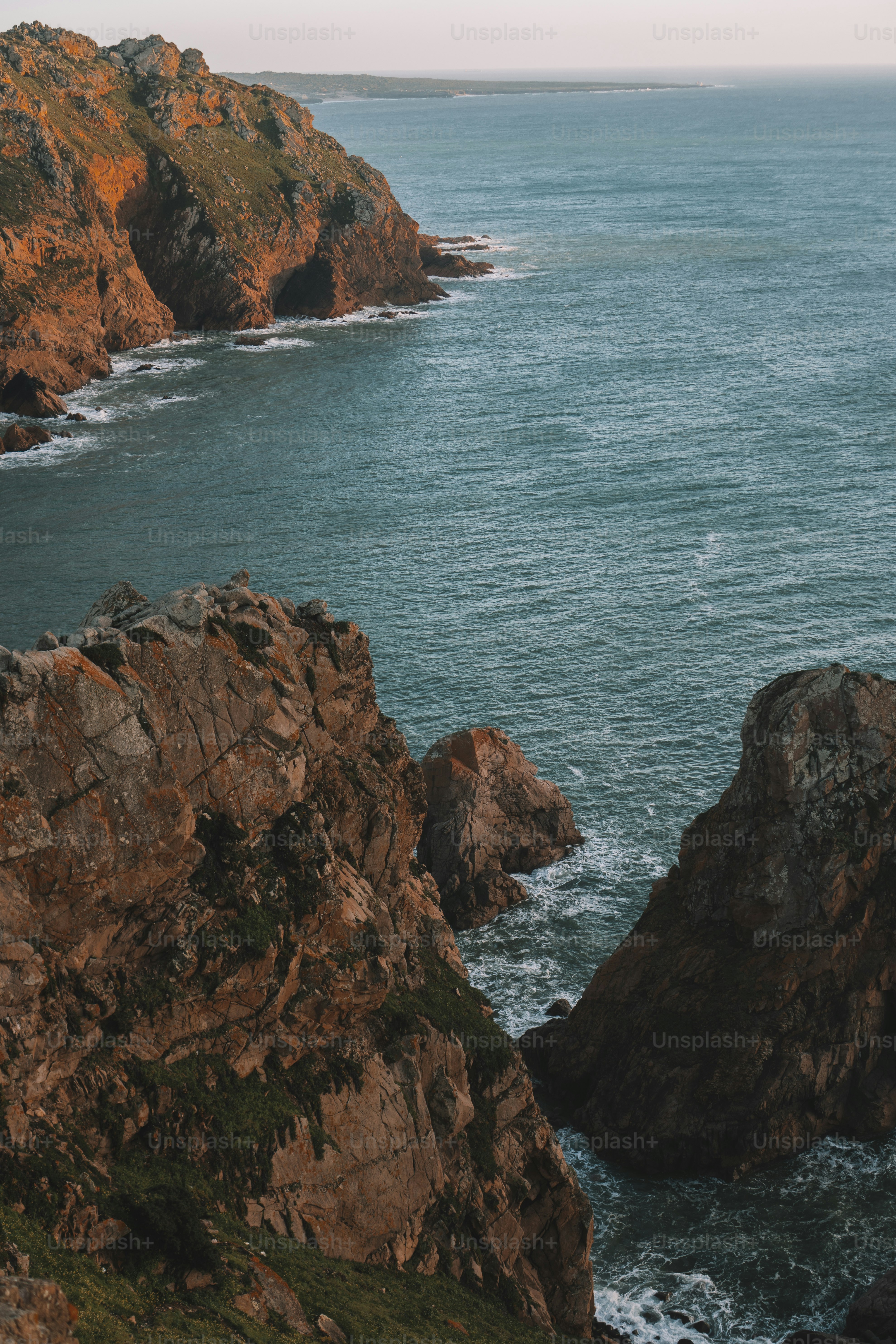 A couple of large rocks sitting on top of a body of water photo ...