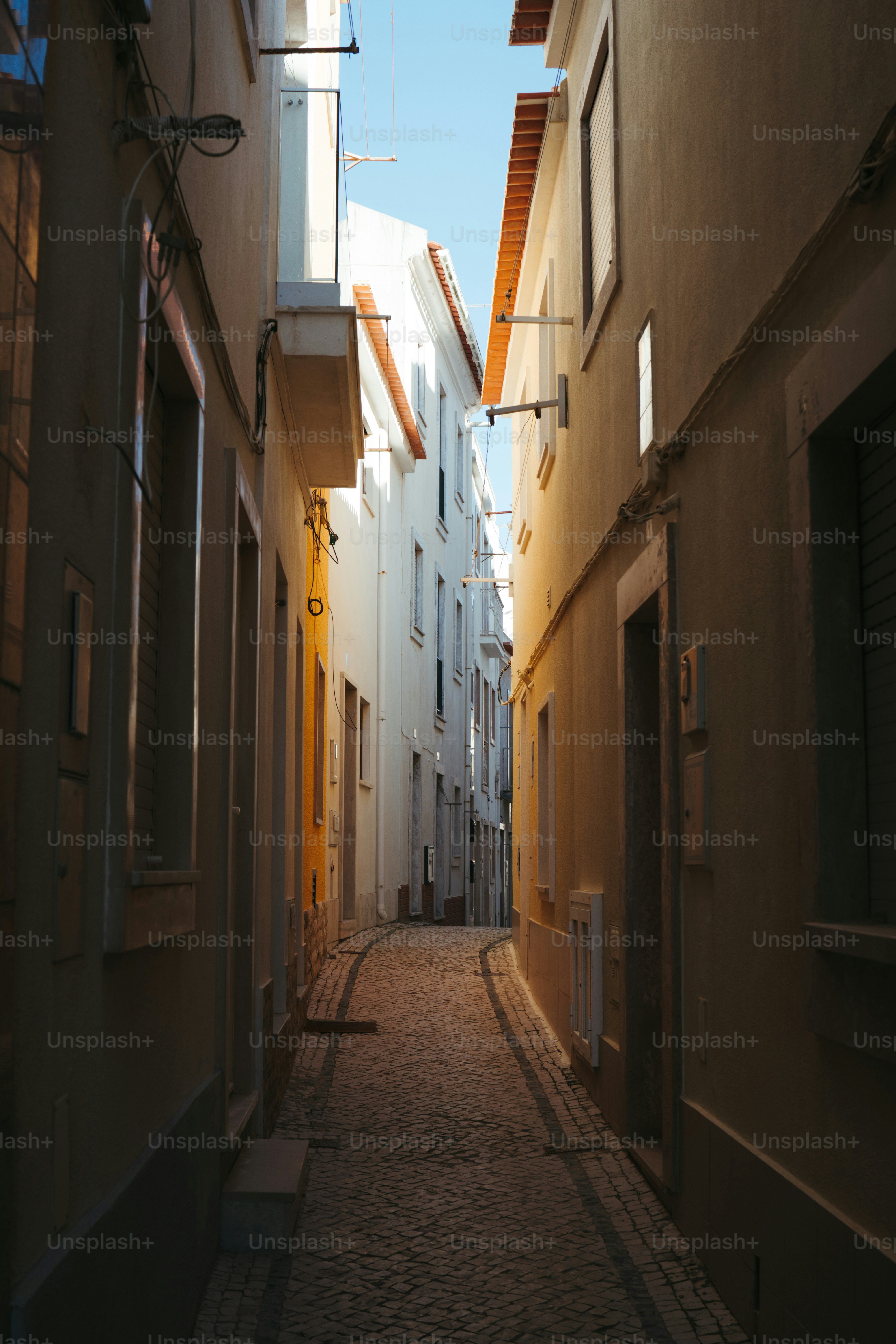 A view of a rooftop from a narrow alley way photo – Housing Image on ...
