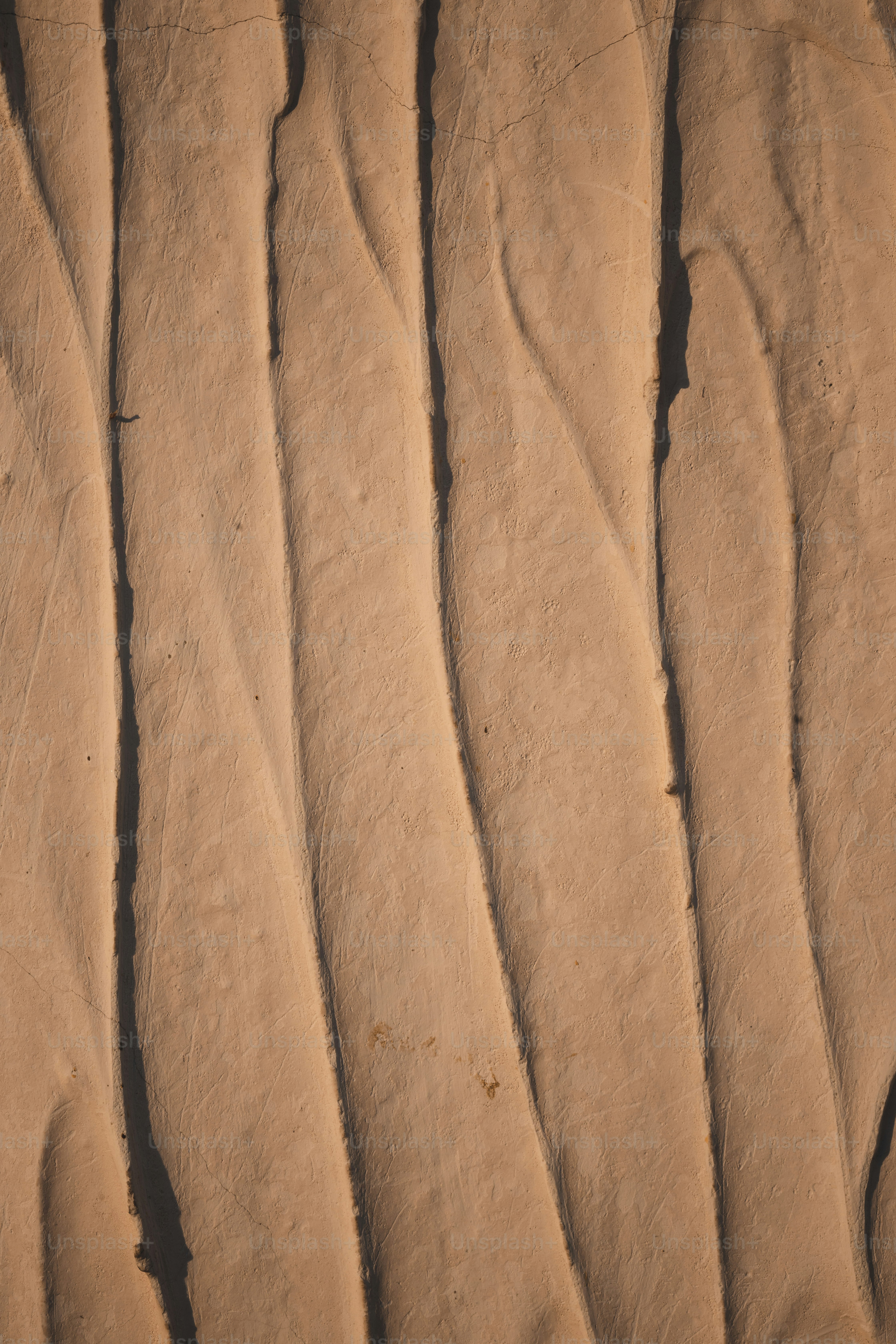 A close up of a sand dune with wavy lines photo – Texture Image on Unsplash
