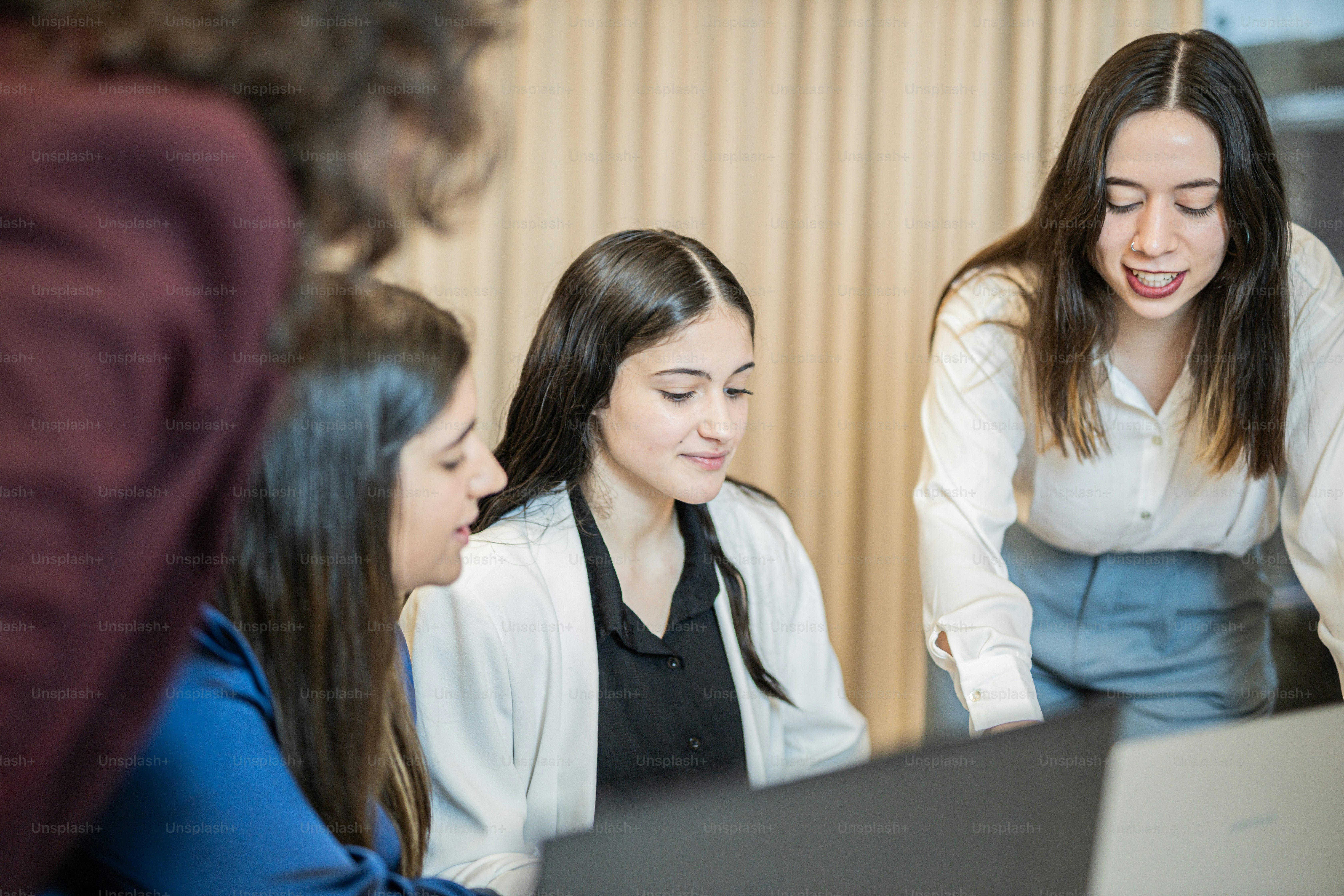 A group of women sitting around a laptop computer photo – Female Image ...